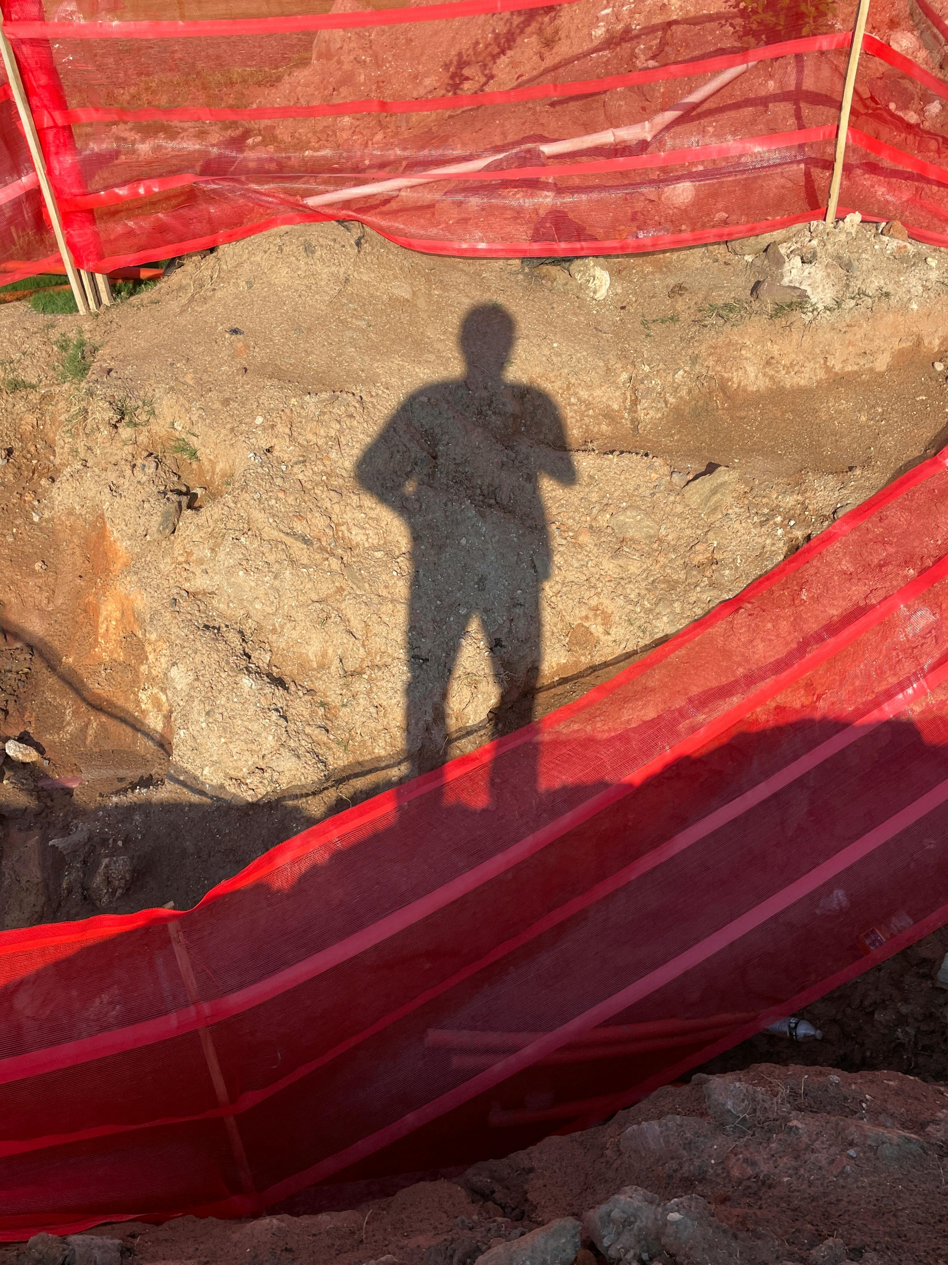 Shadow on Construction Site with Red Barrier · Free Stock Photo