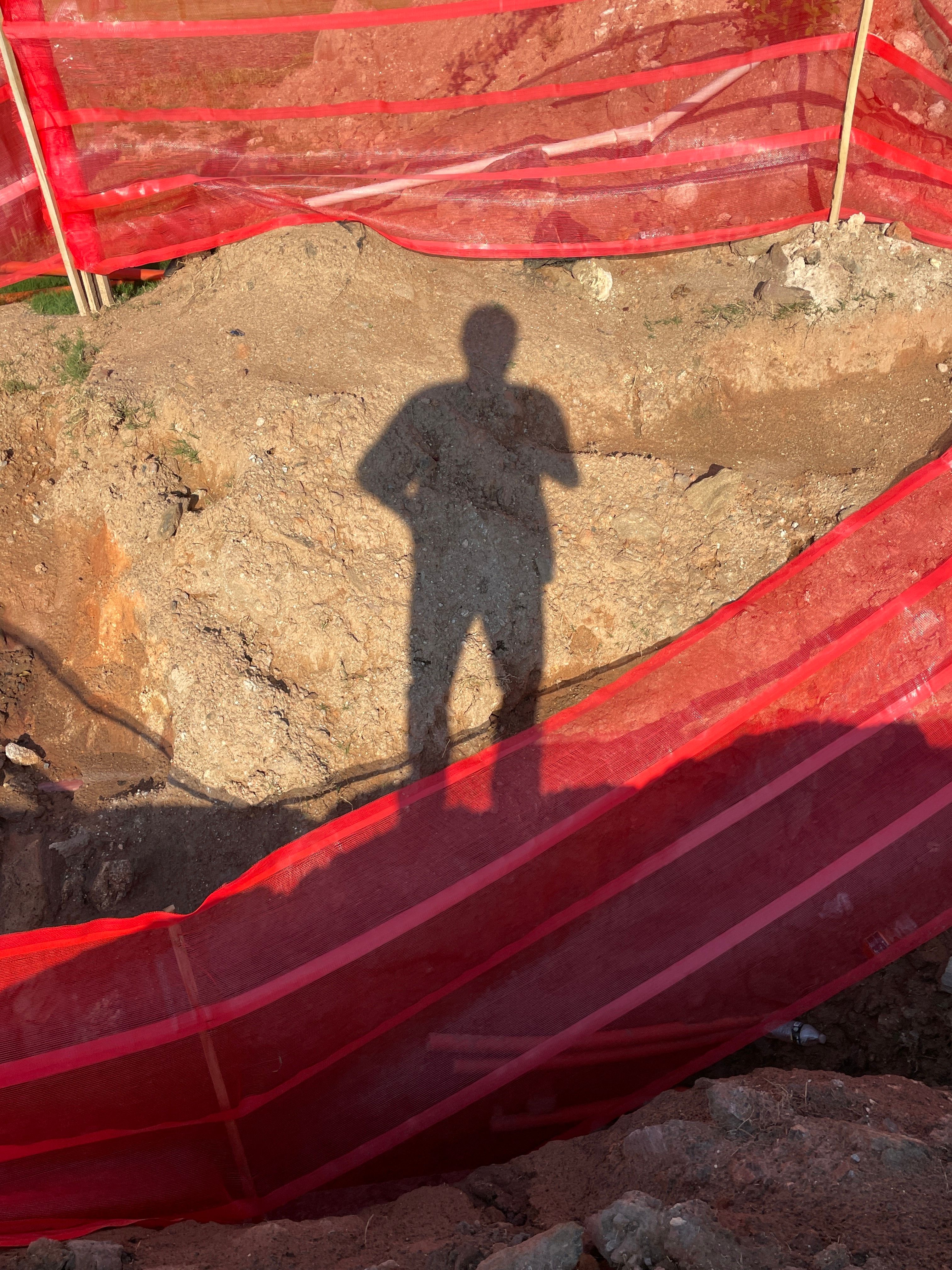 Shadow on Construction Site with Red Barrier · Free Stock Photo