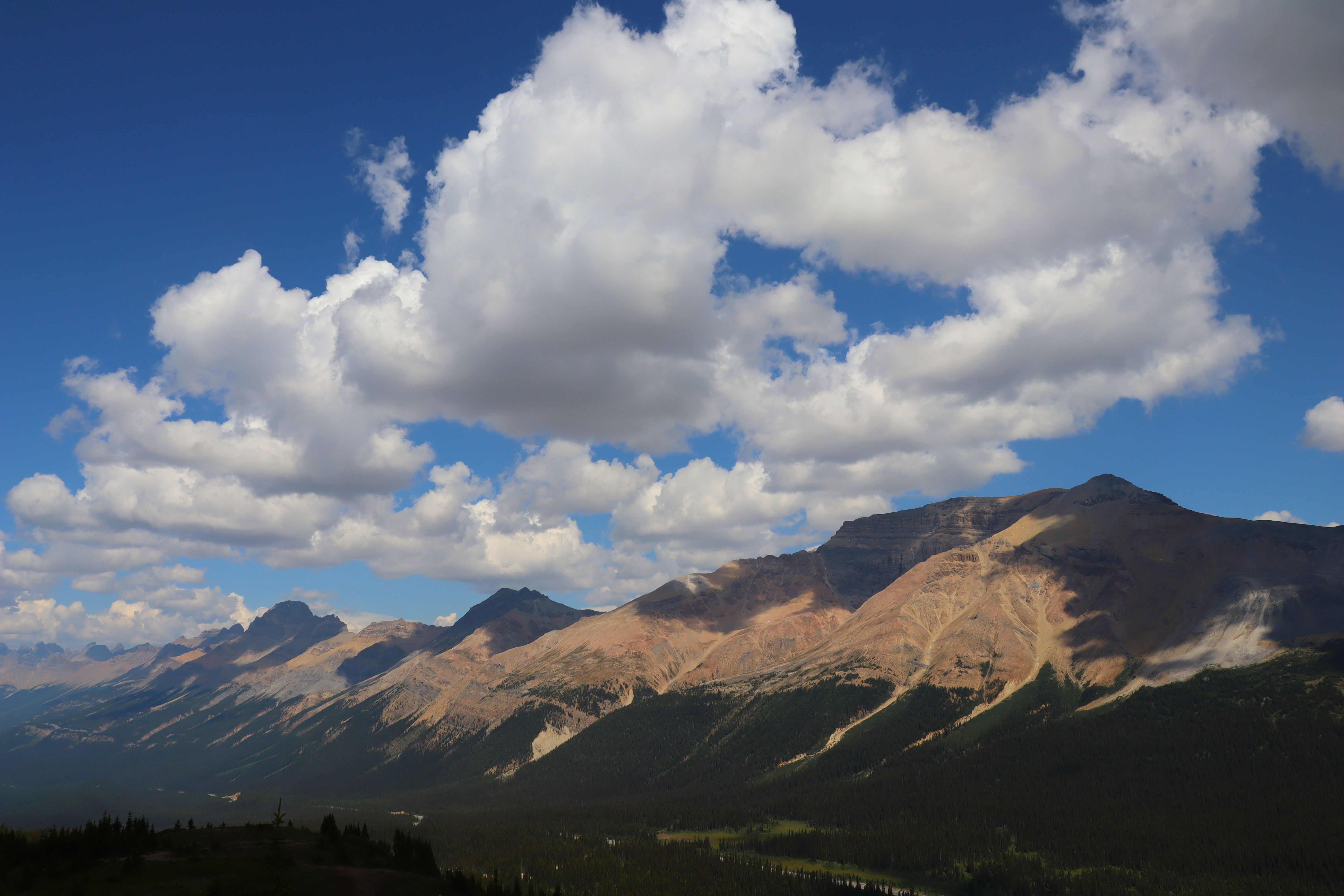 Majestic Canadian Rockies under a Cloudy Sky · Free Stock Photo