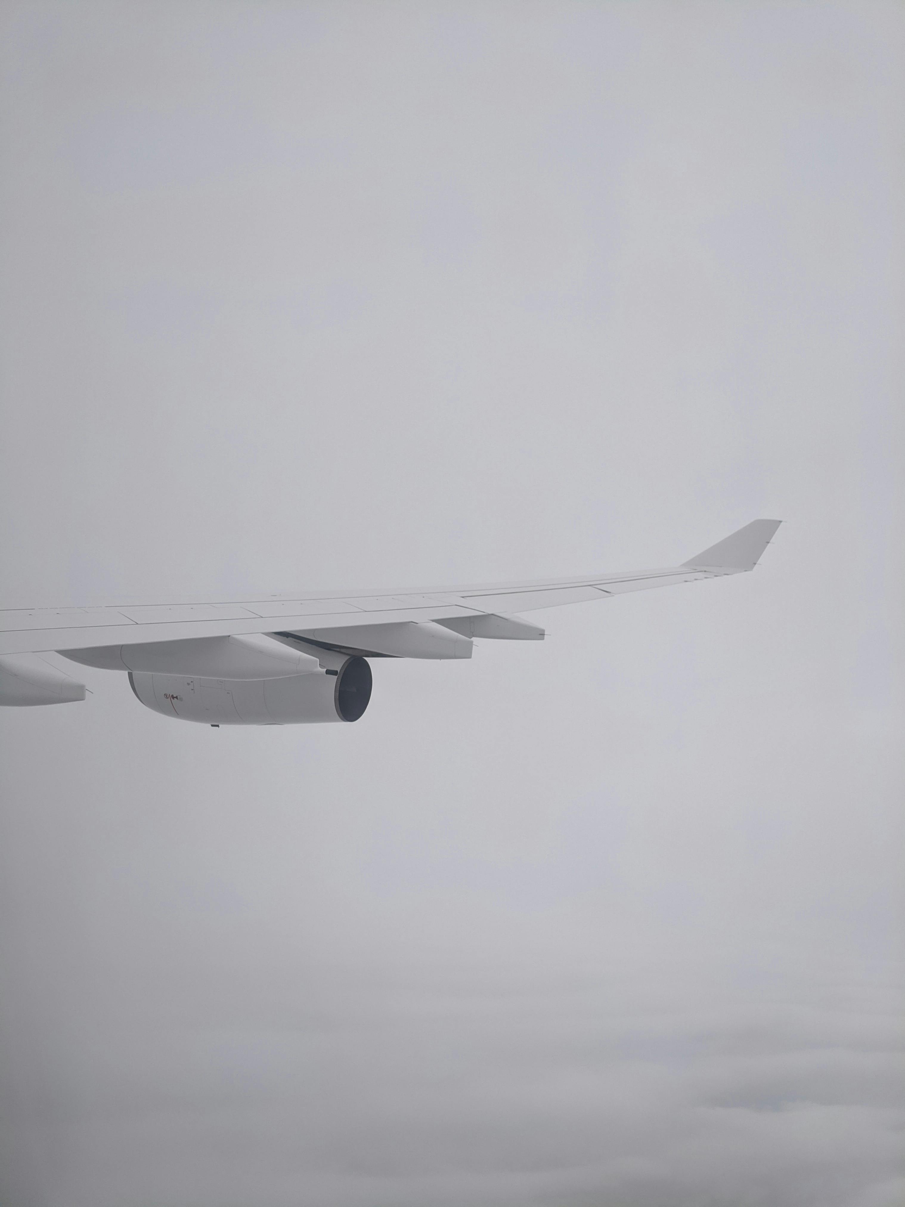 Minimalist Airplane Wing in Cloudy Sky · Free Stock Photo