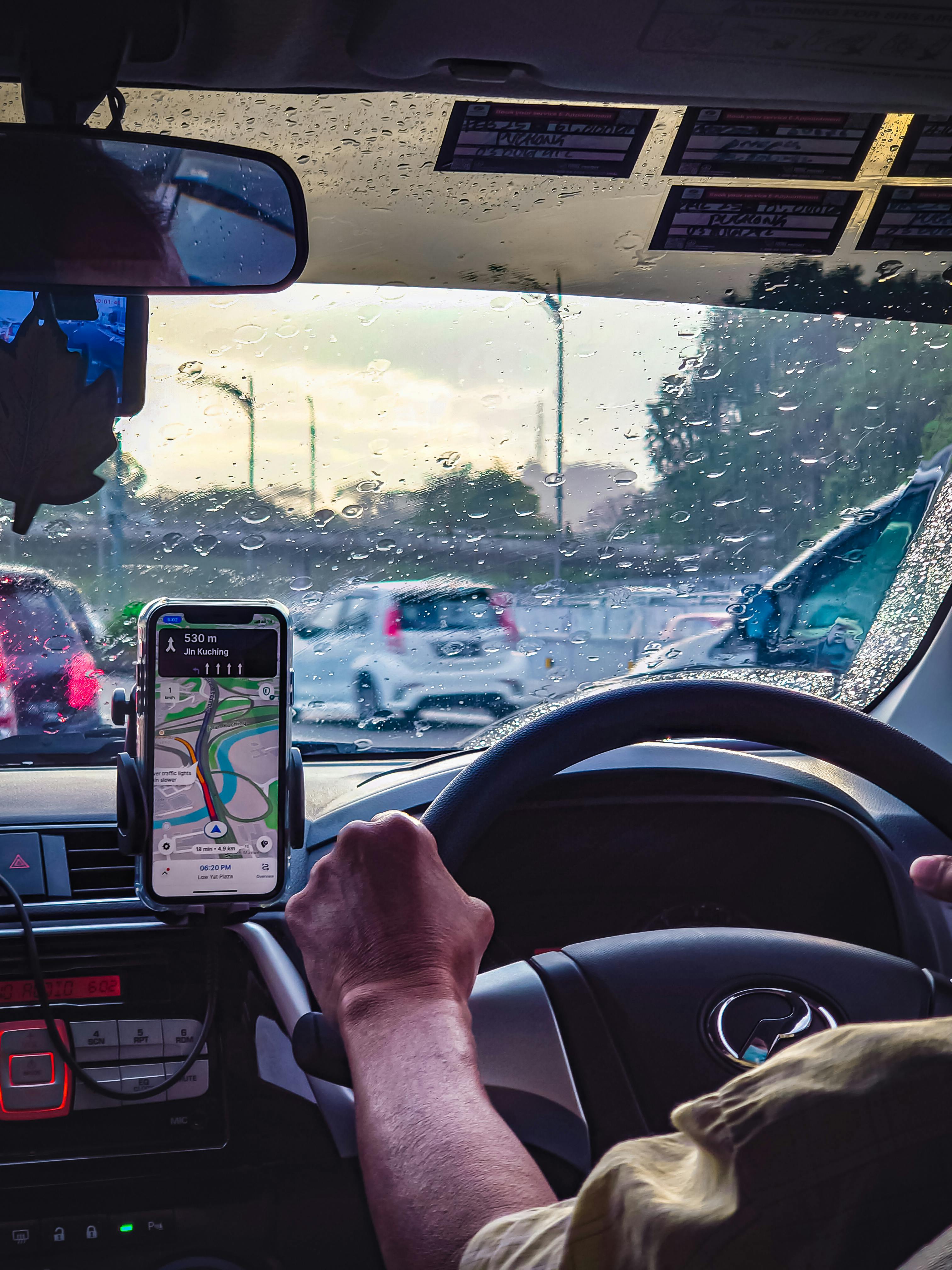 Driving in Rainy Weather with GPS Navigation · Free Stock Photo