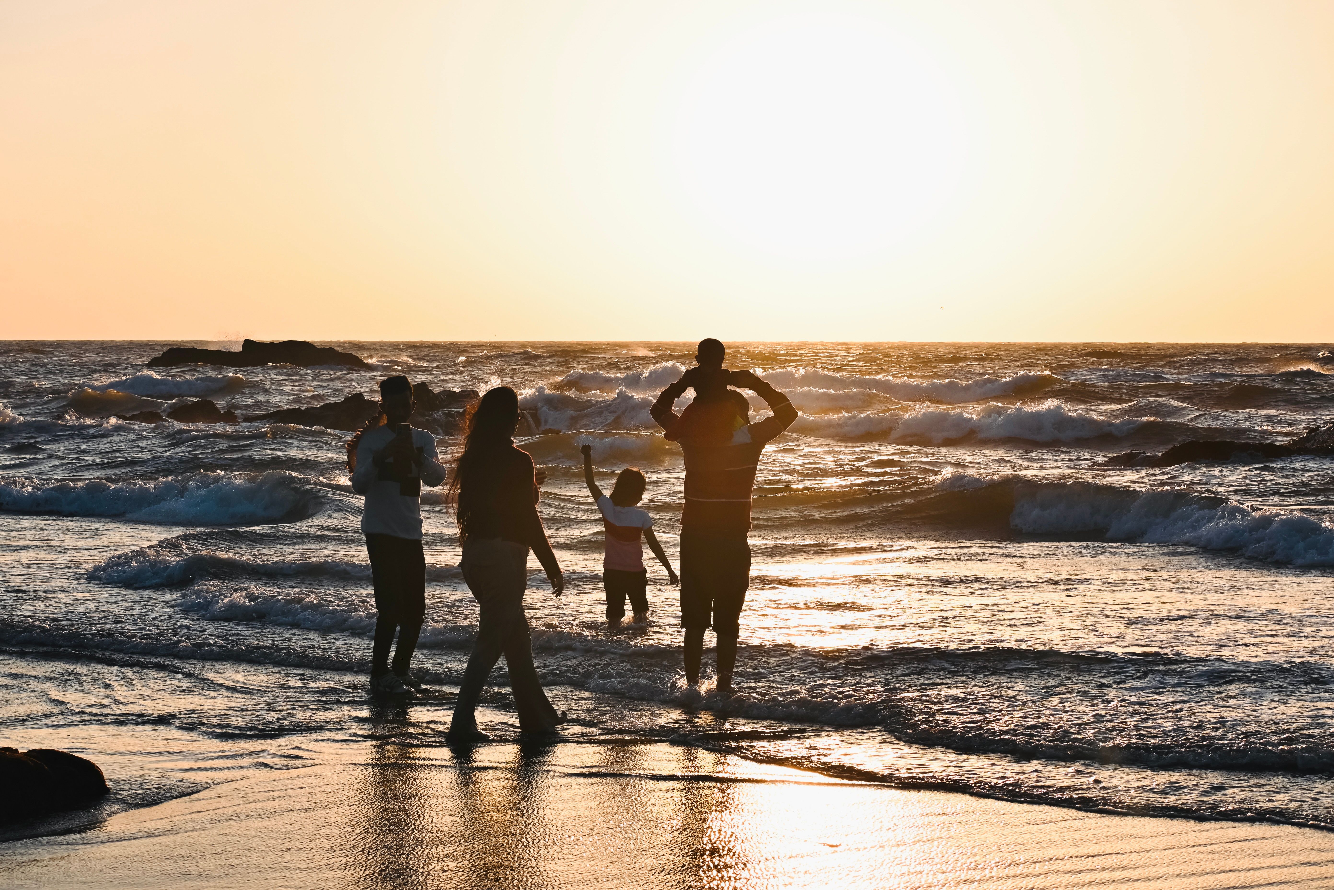 Family Enjoying Sunset at Goa Beach · Free Stock Photo