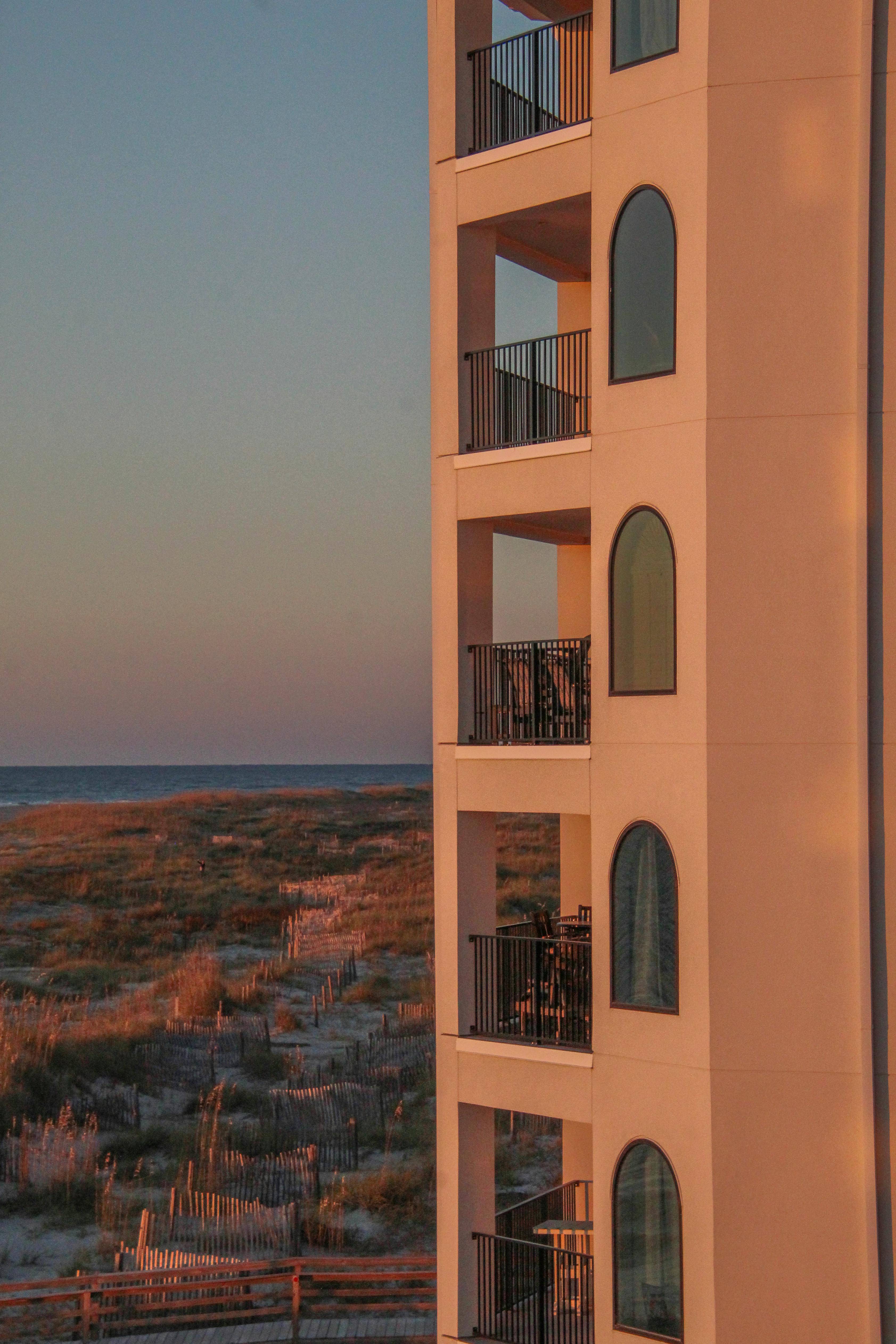 Beachfront Building at Sunrise with Pastel Sky · Free Stock Photo