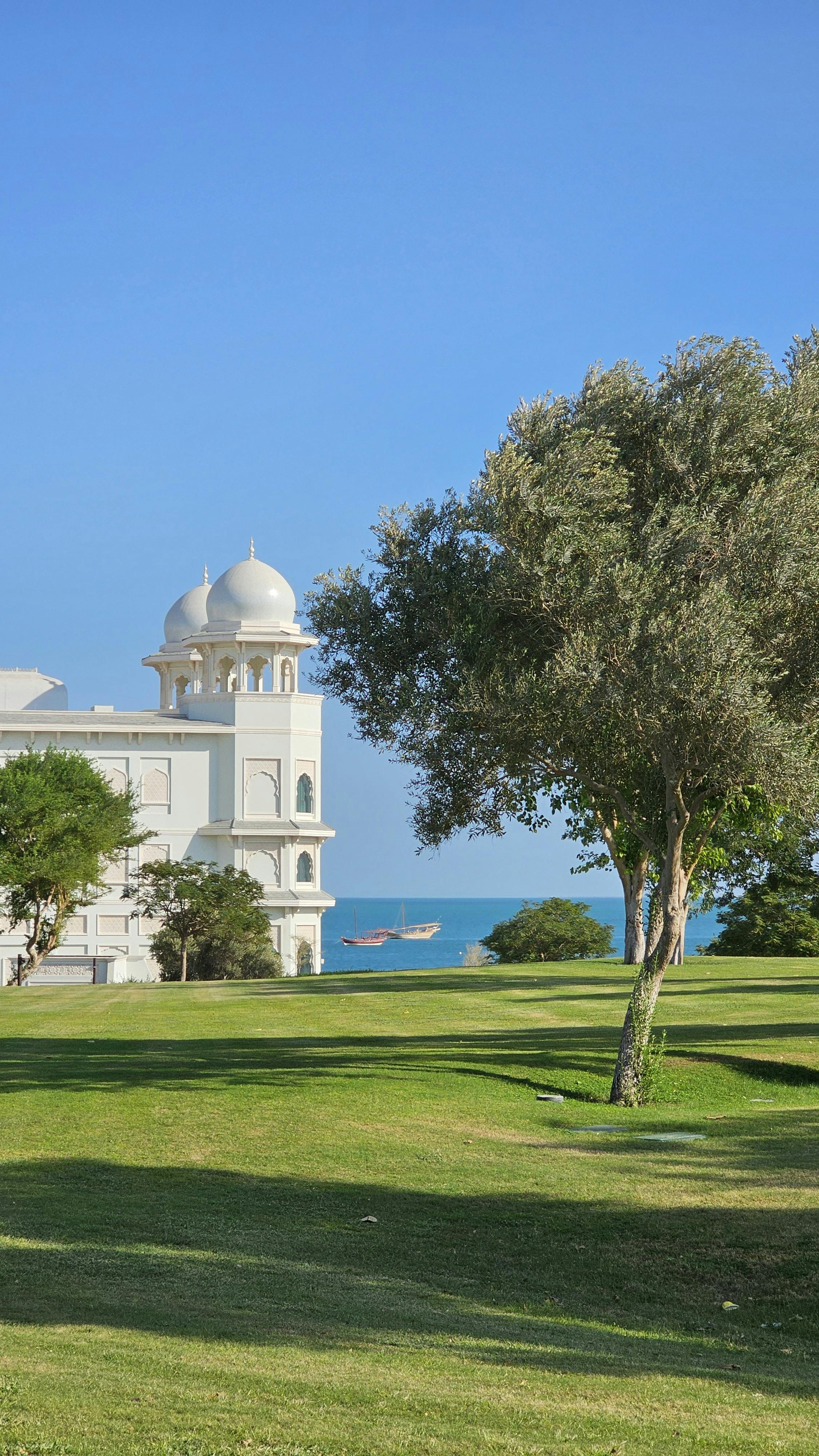 Scenic Coastal Building with Dome and Gardens · Free Stock Photo