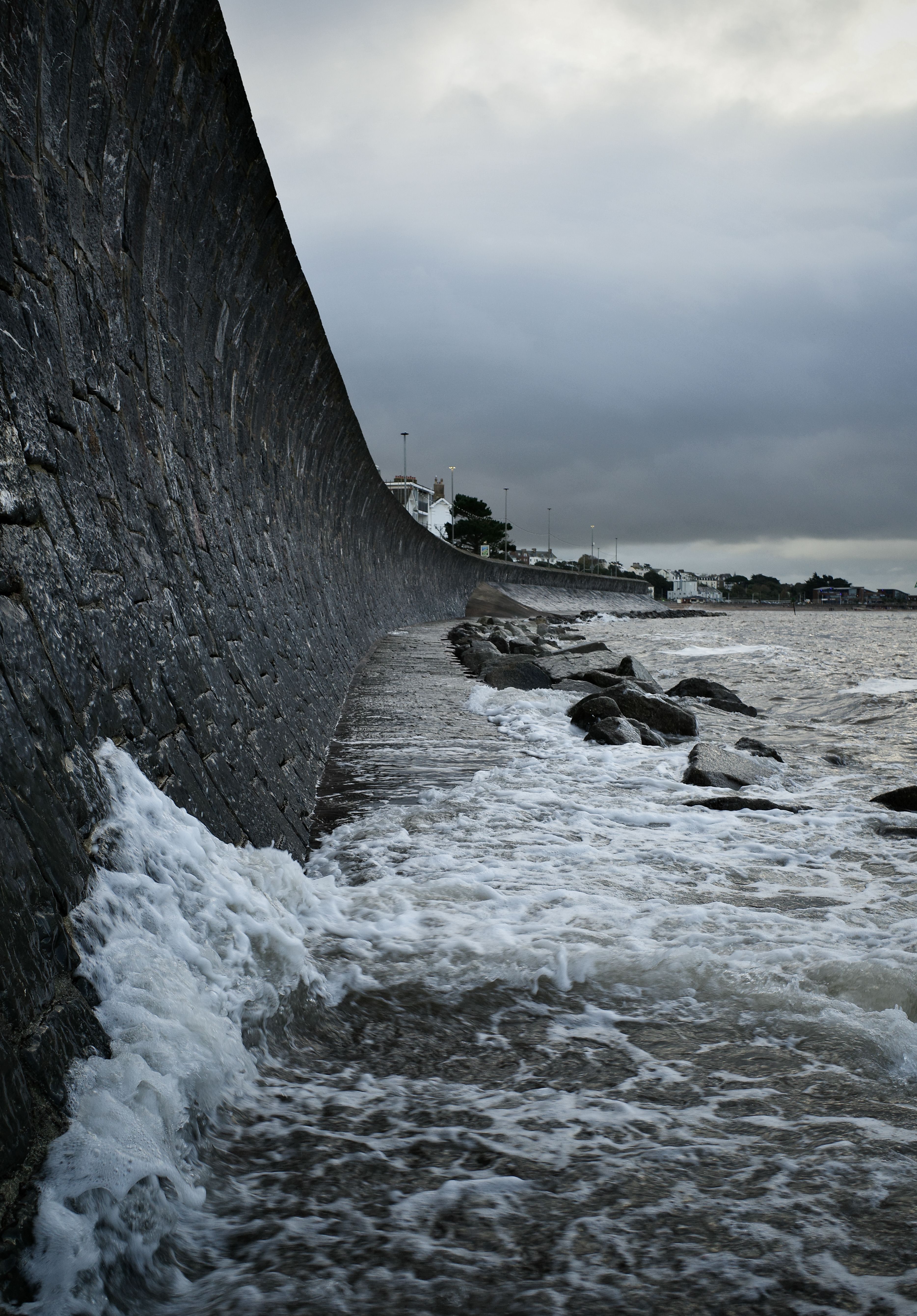 Dramatic Coastal Sea Wall Against Stormy Sky · Free Stock Photo