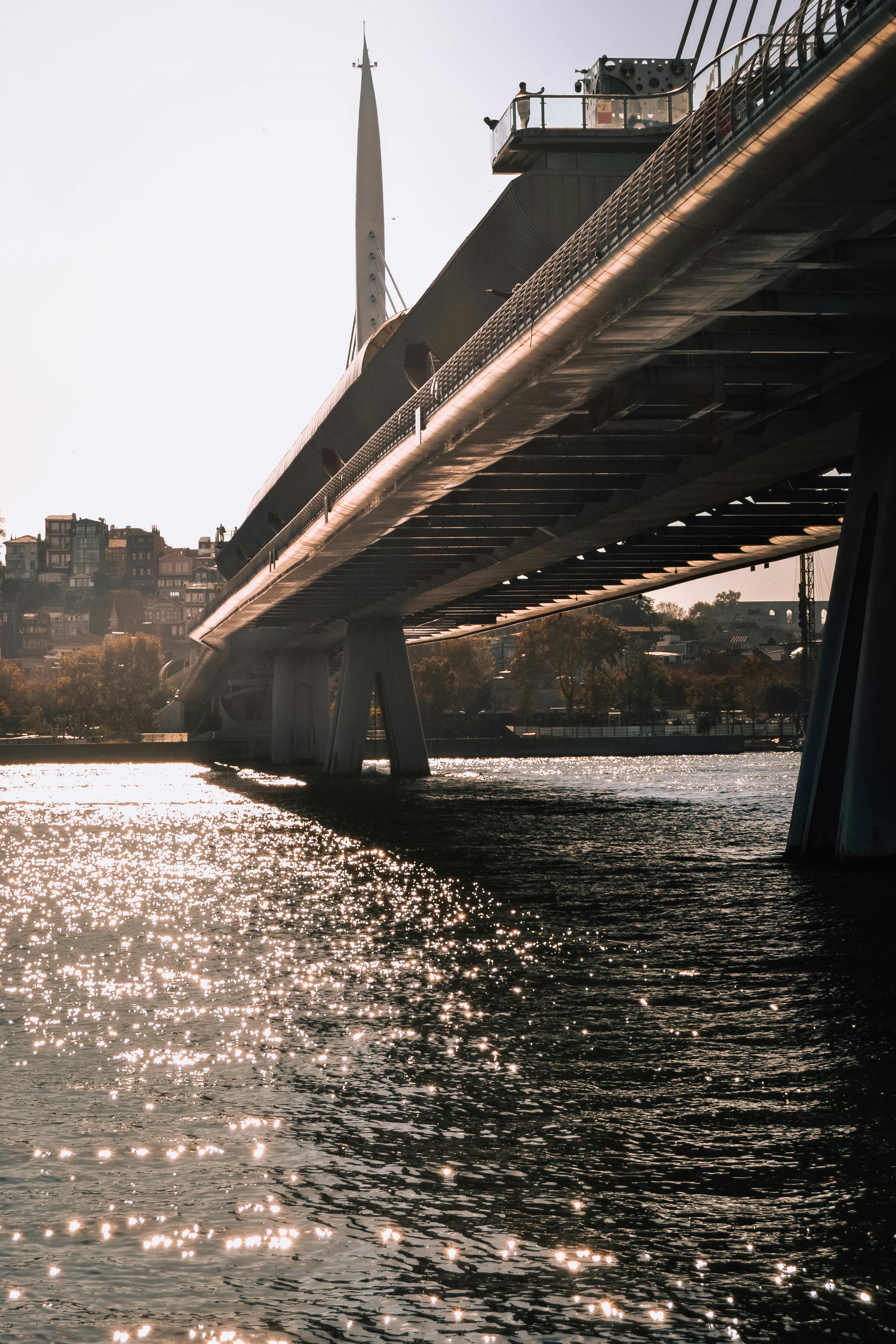 Modern Bridge Over Sparkling River at Sunset · Free Stock Photo