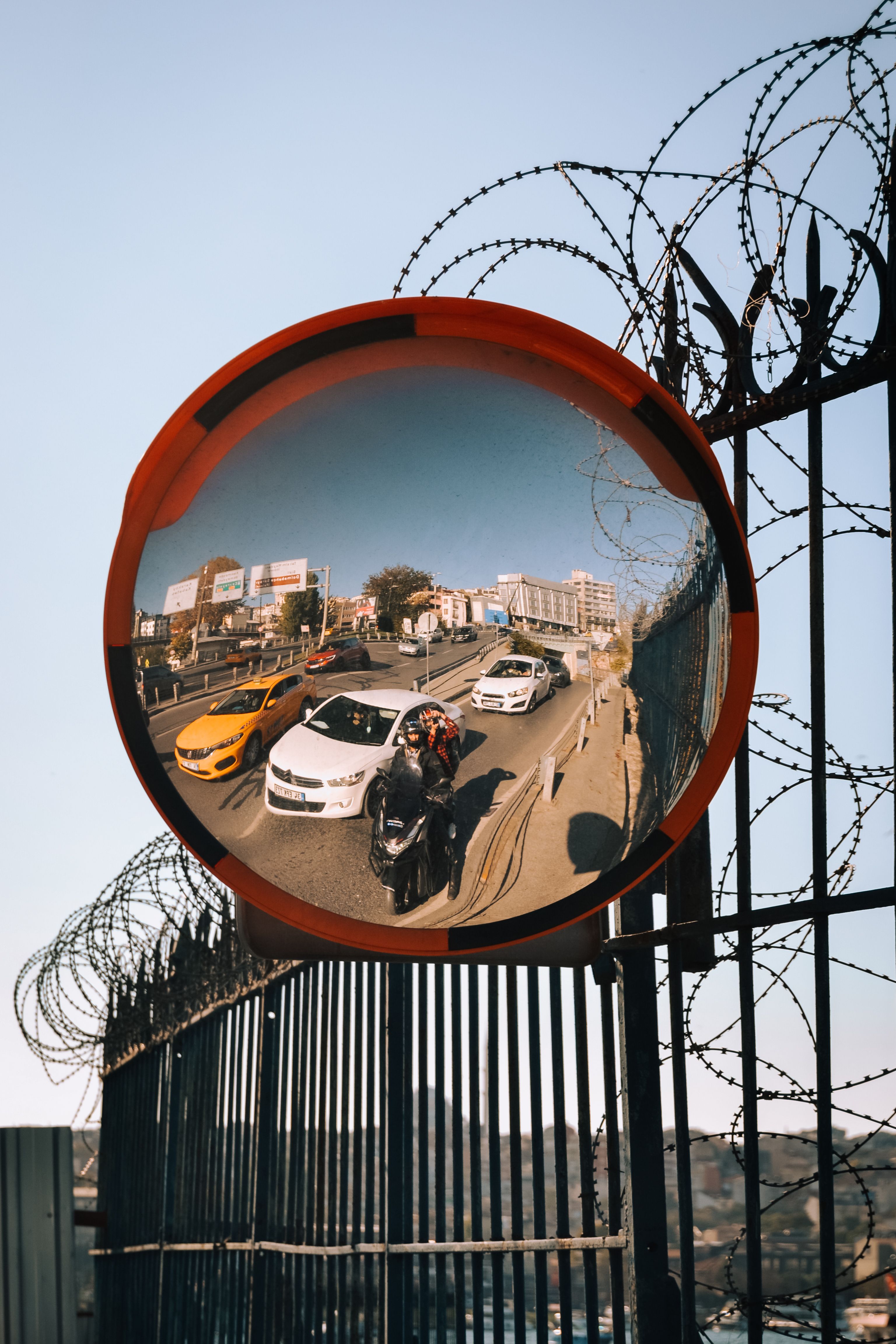 City Traffic Reflected in Convex Mirror · Free Stock Photo