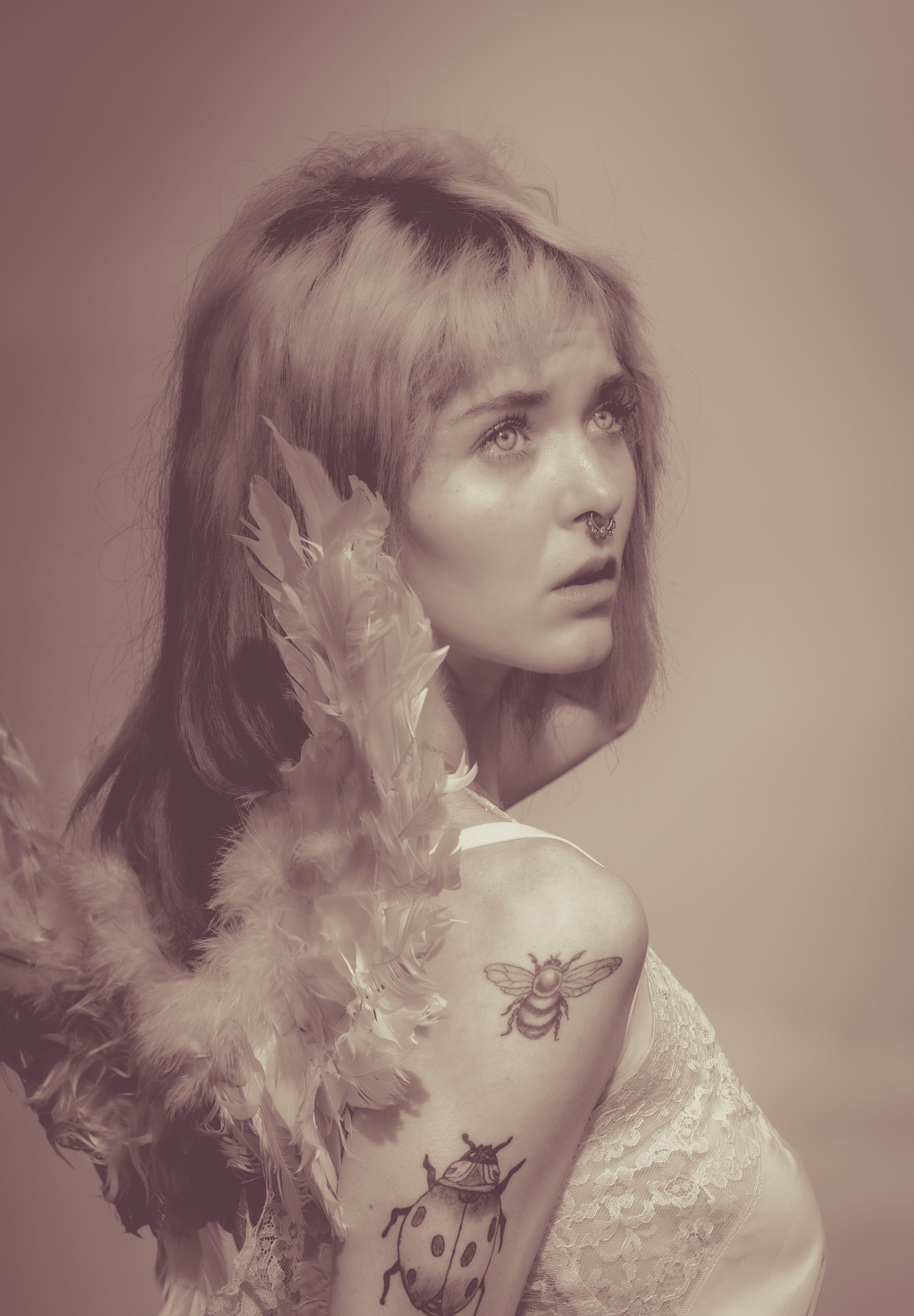 Artistic Portrait with Feathered Wings and Tattoos · Free Stock Photo