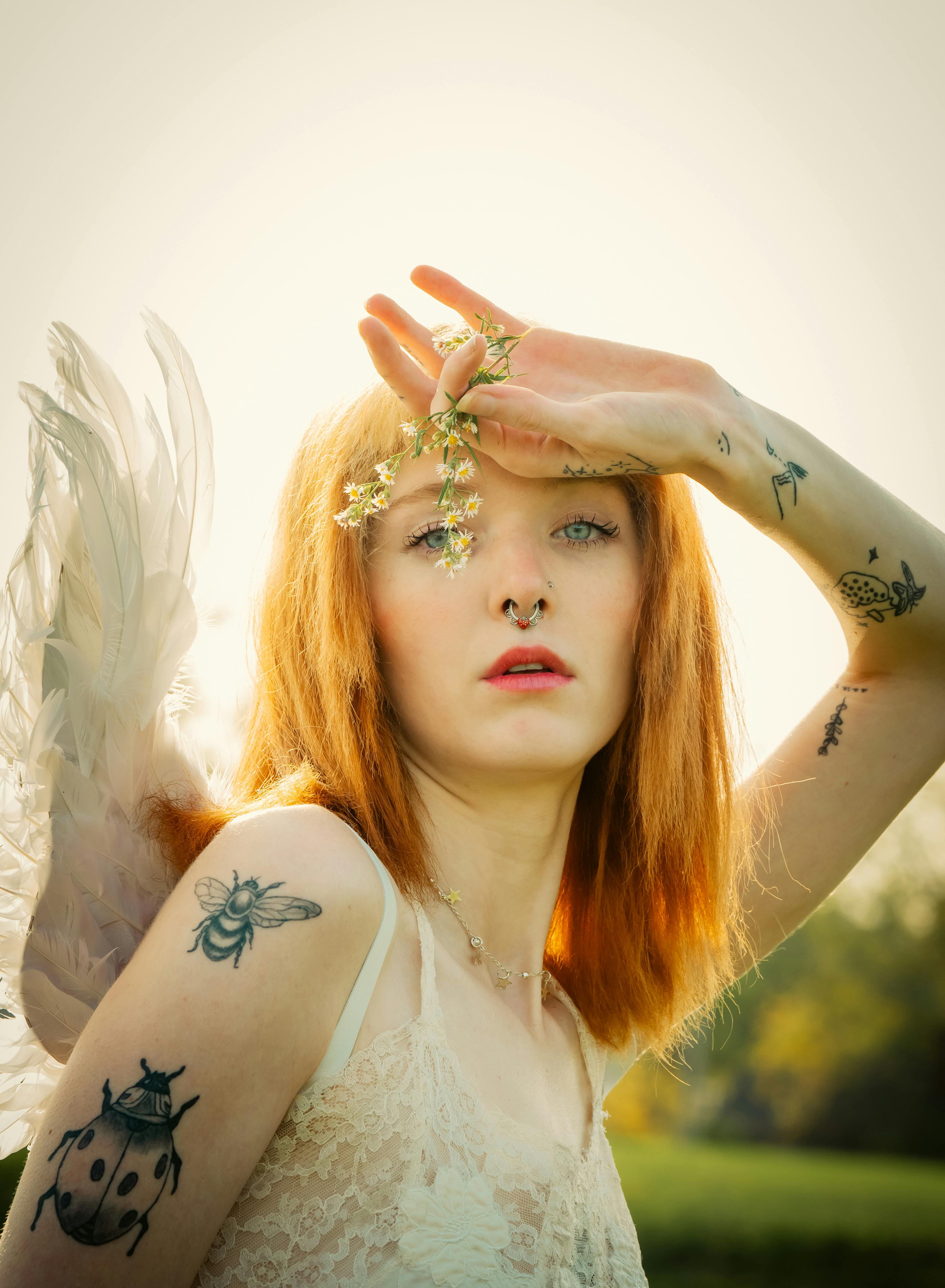 Ethereal Angelic Figure with Tattoos in Sunlight · Free Stock Photo