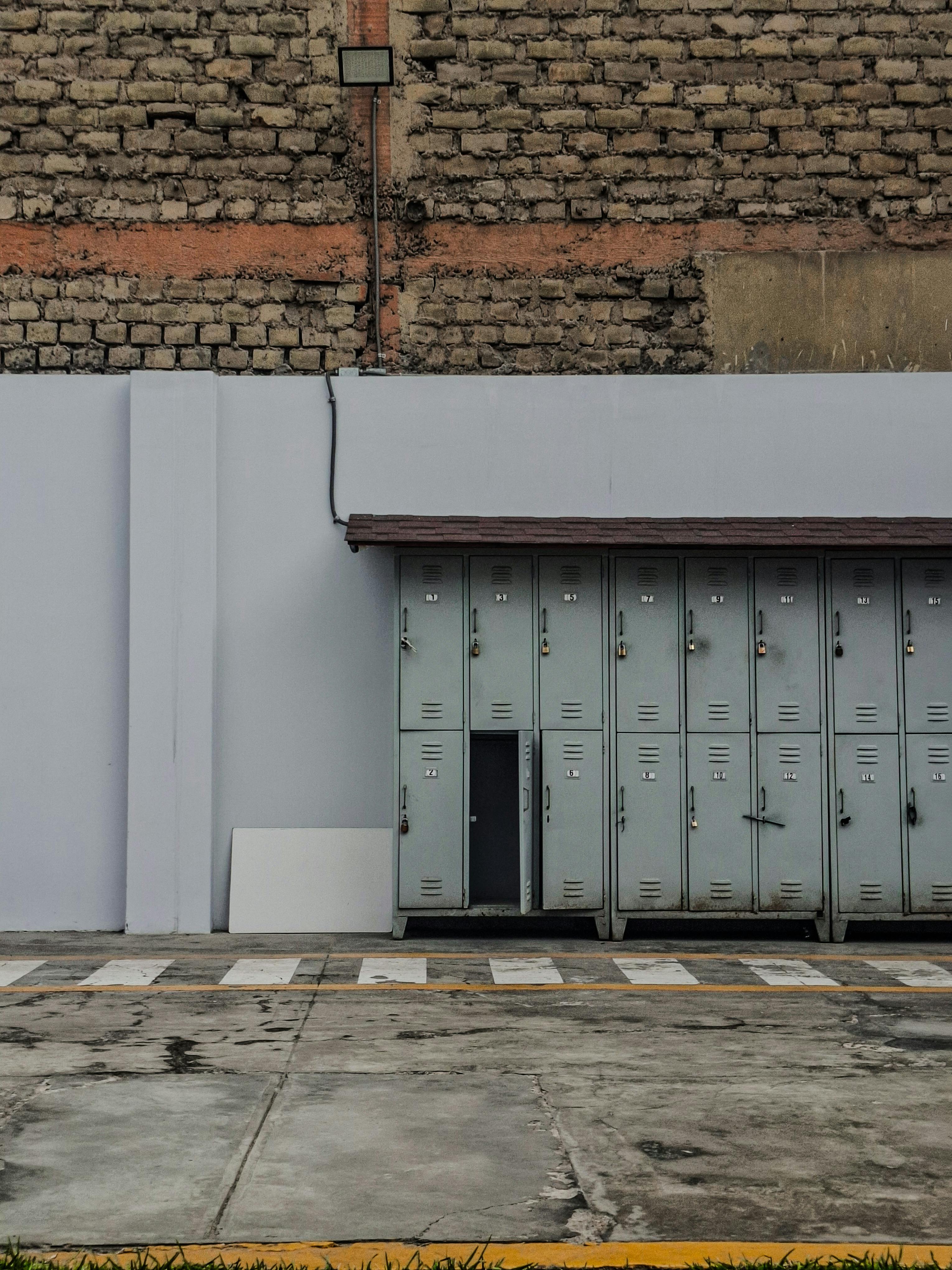 Minimalistic Urban Locker Setup Against Brick Wall · Free Stock Photo