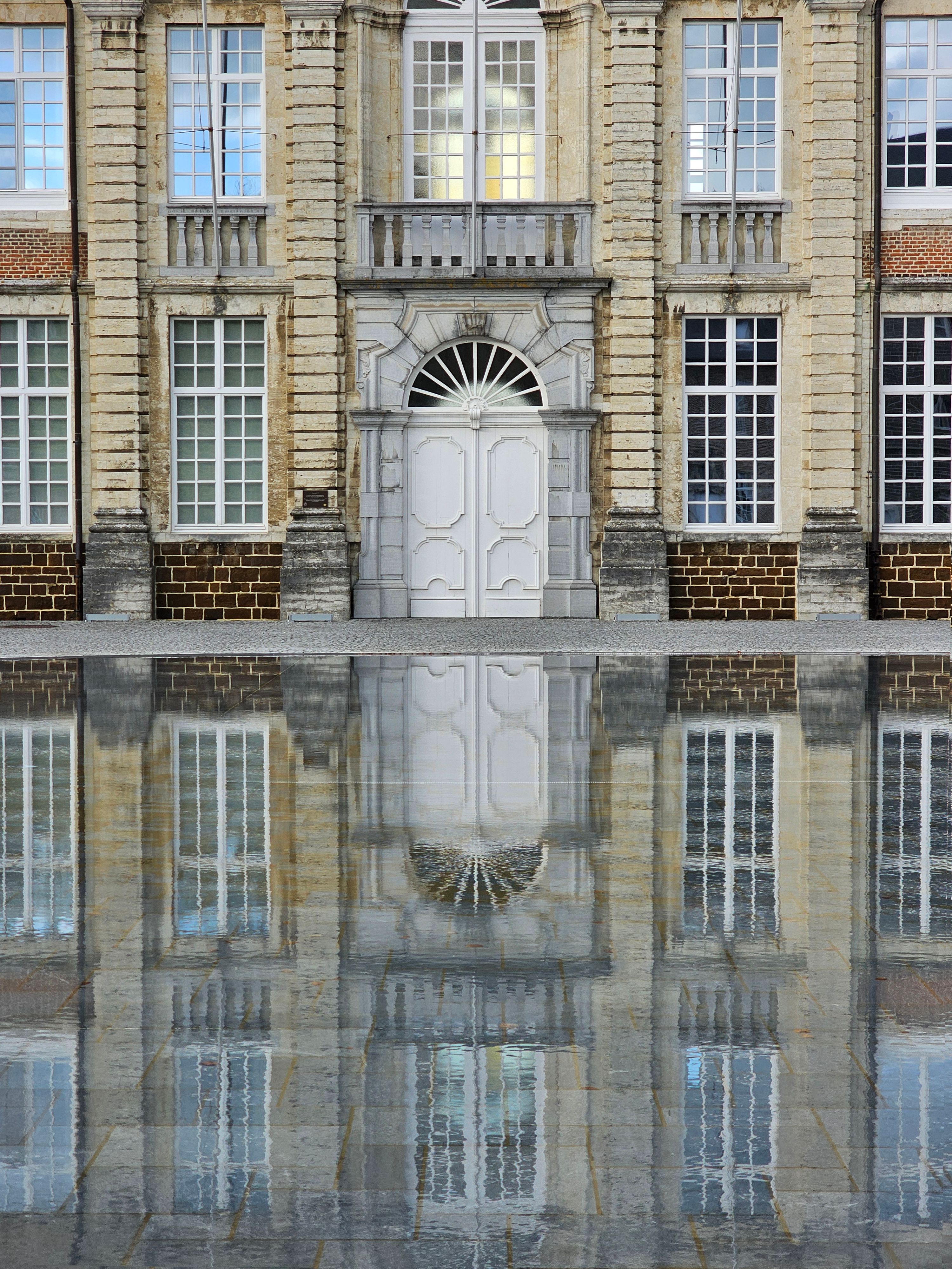 Elegant Reflected Facade of Historic Belgian Building · Free Stock Photo