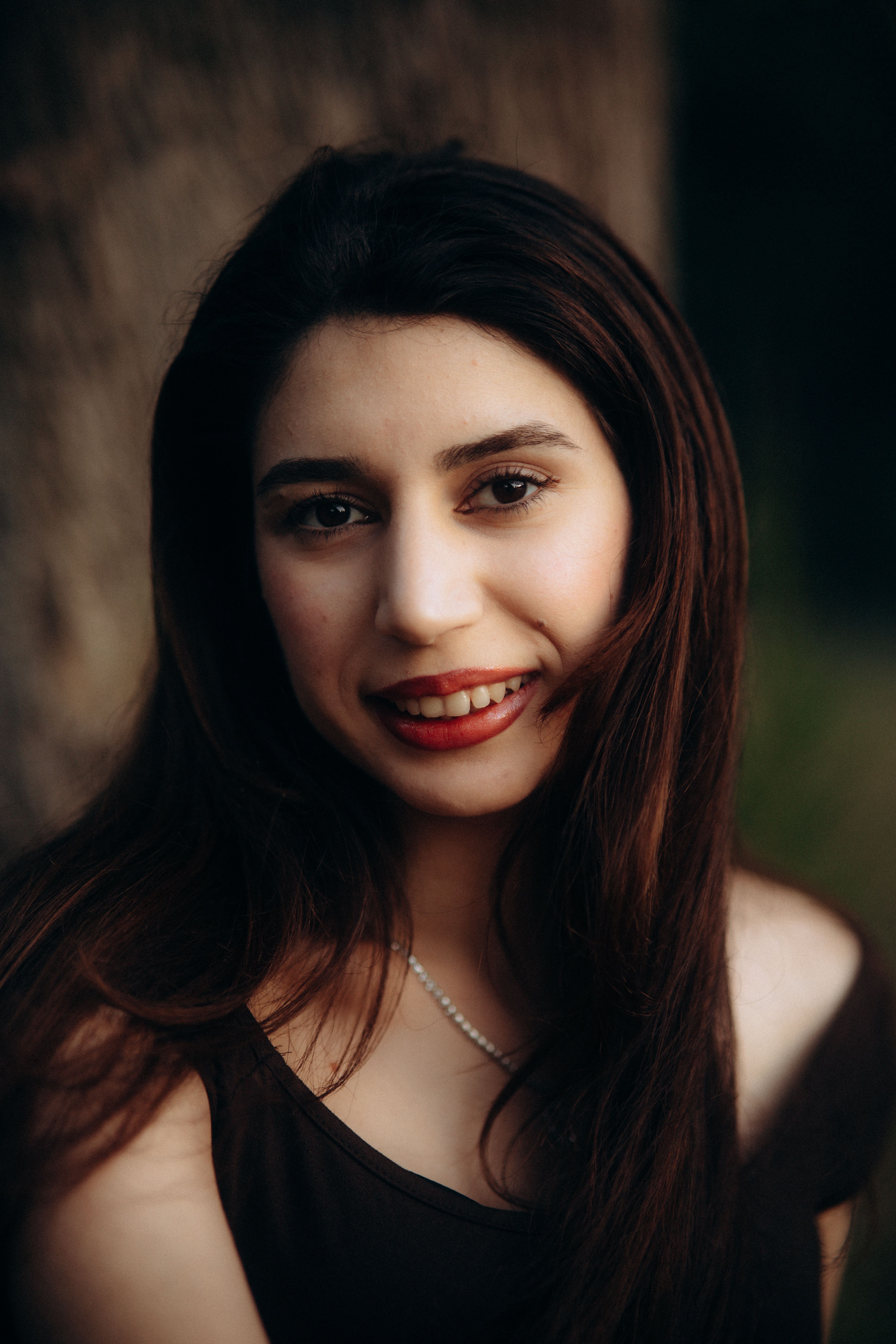 Warm Portrait of a Smiling Woman Outdoors · Free Stock Photo