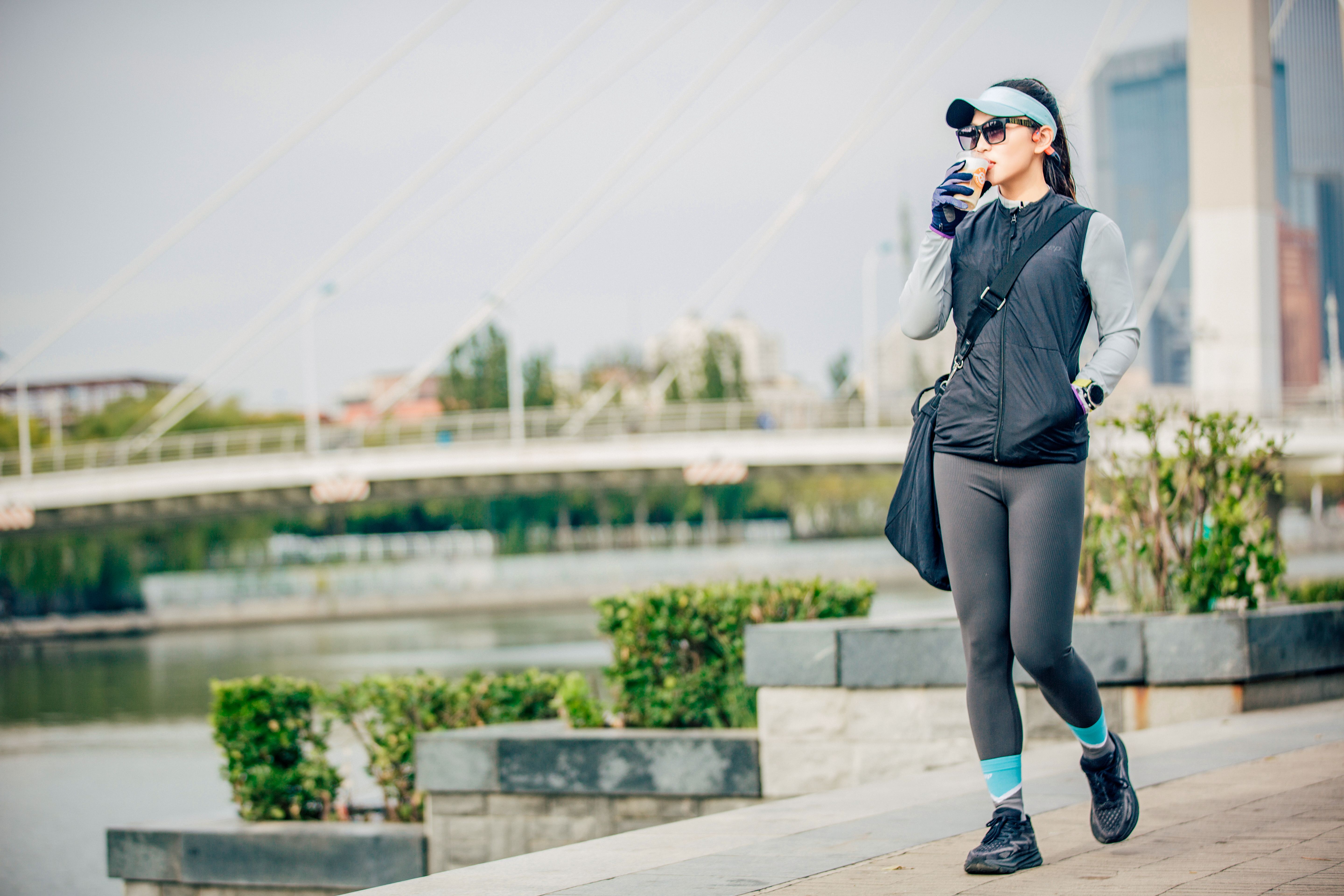 Woman Jogging by River Wearing Activewear · Free Stock Photo