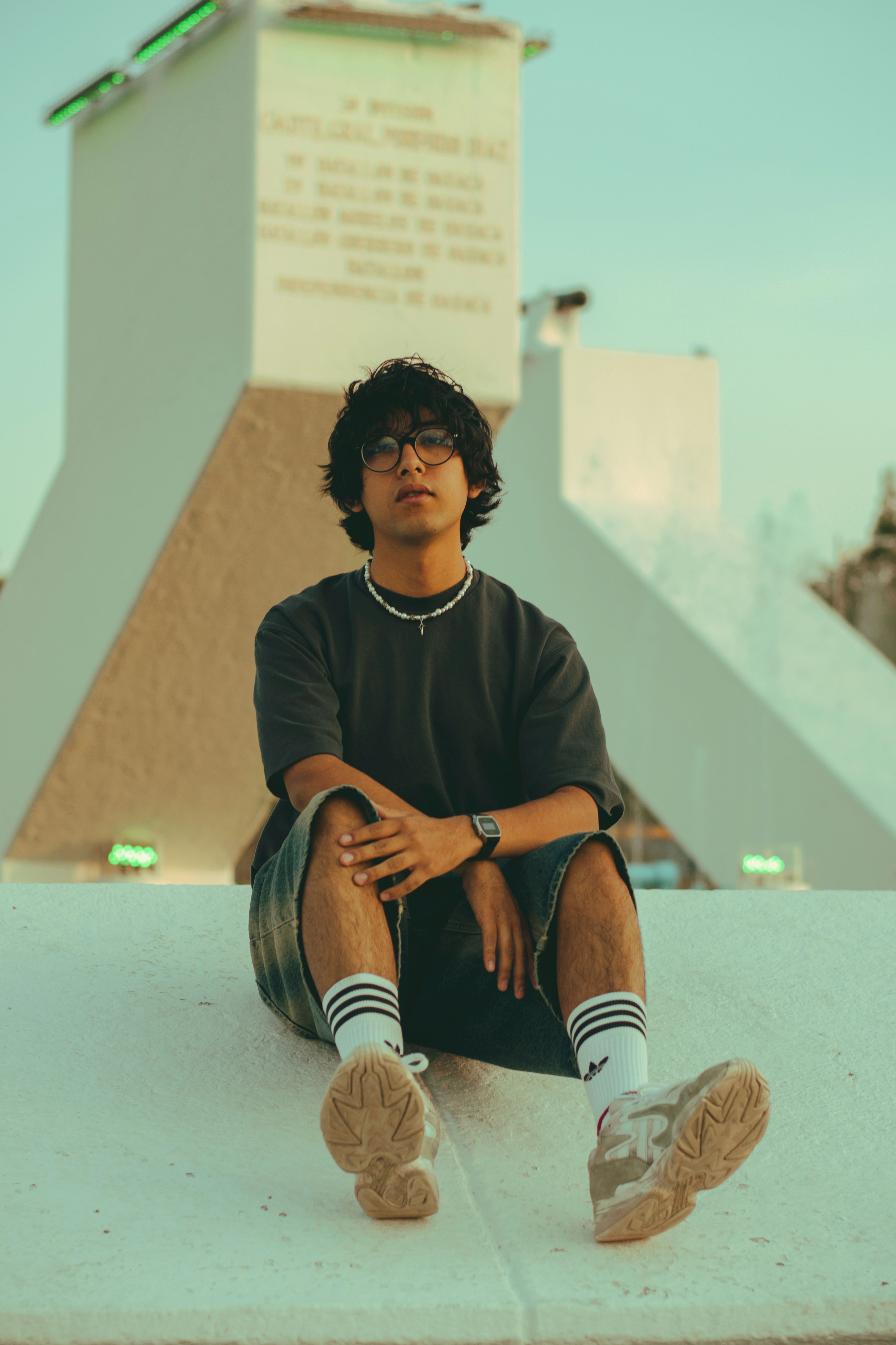 Young Man Relaxing Outdoors at Dusk · Free Stock Photo