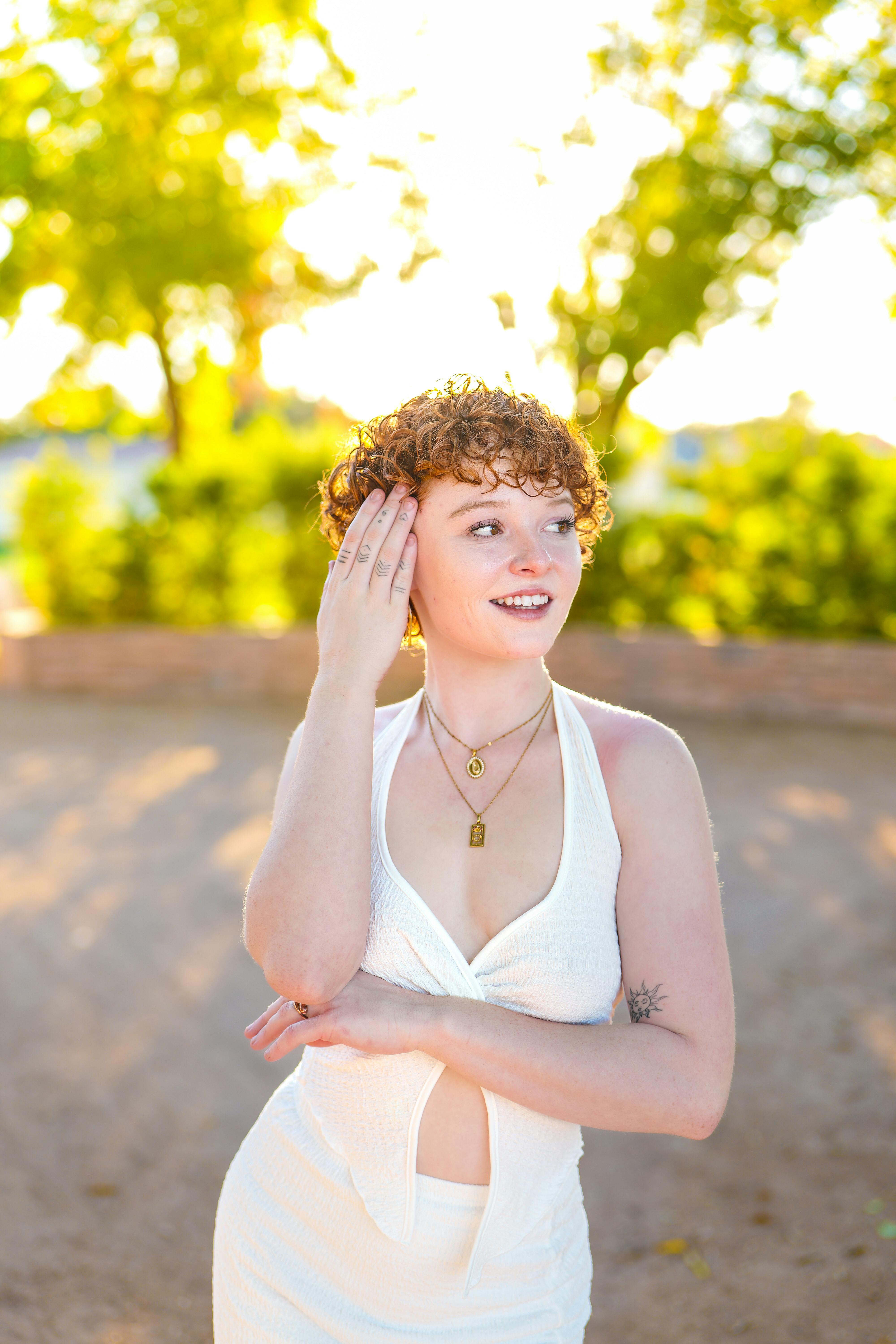 Sunlit Portrait of a Woman in White Dress Outdoors · Free Stock Photo
