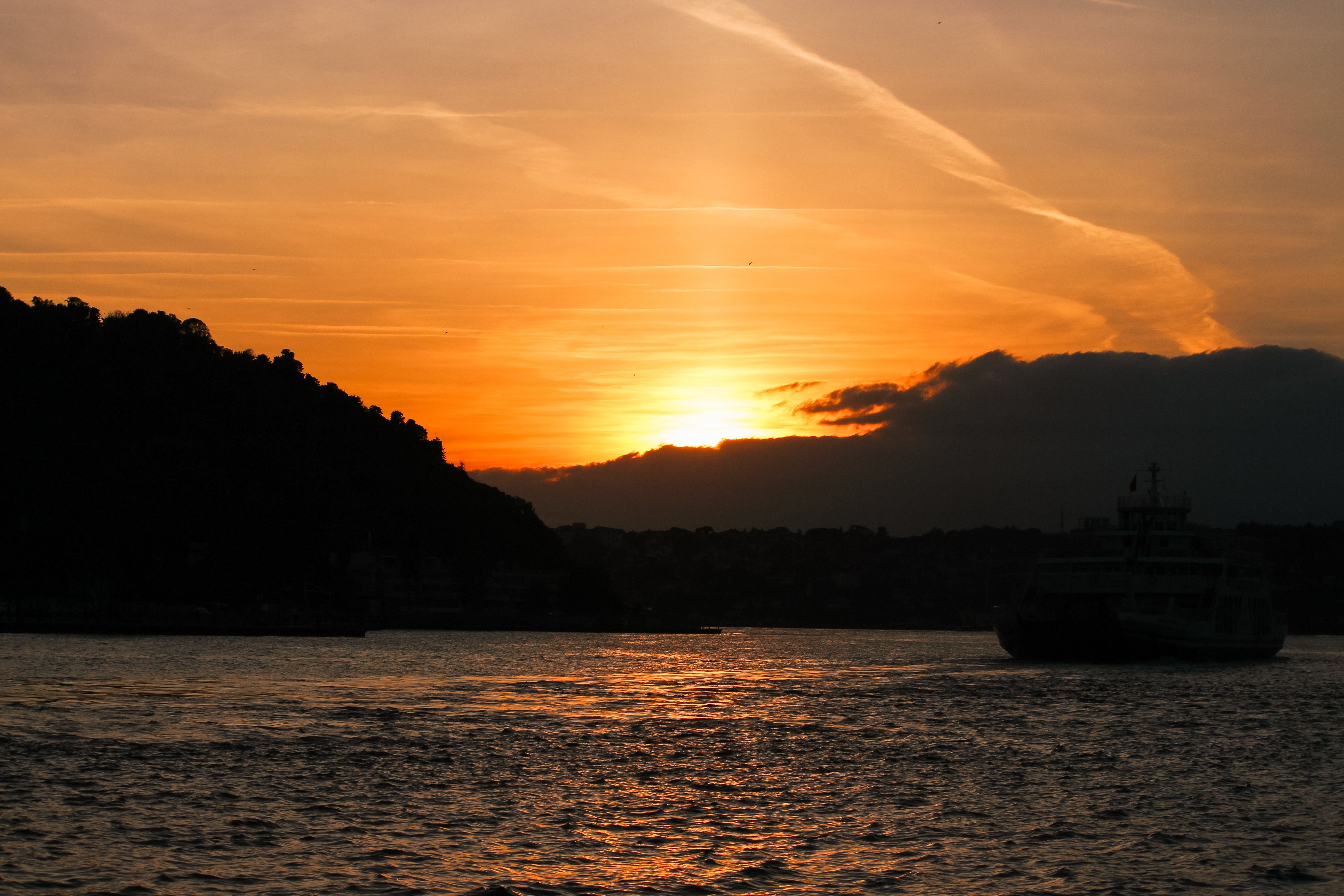 Dramatic Sunset over a Silhouetted Ferry · Free Stock Photo