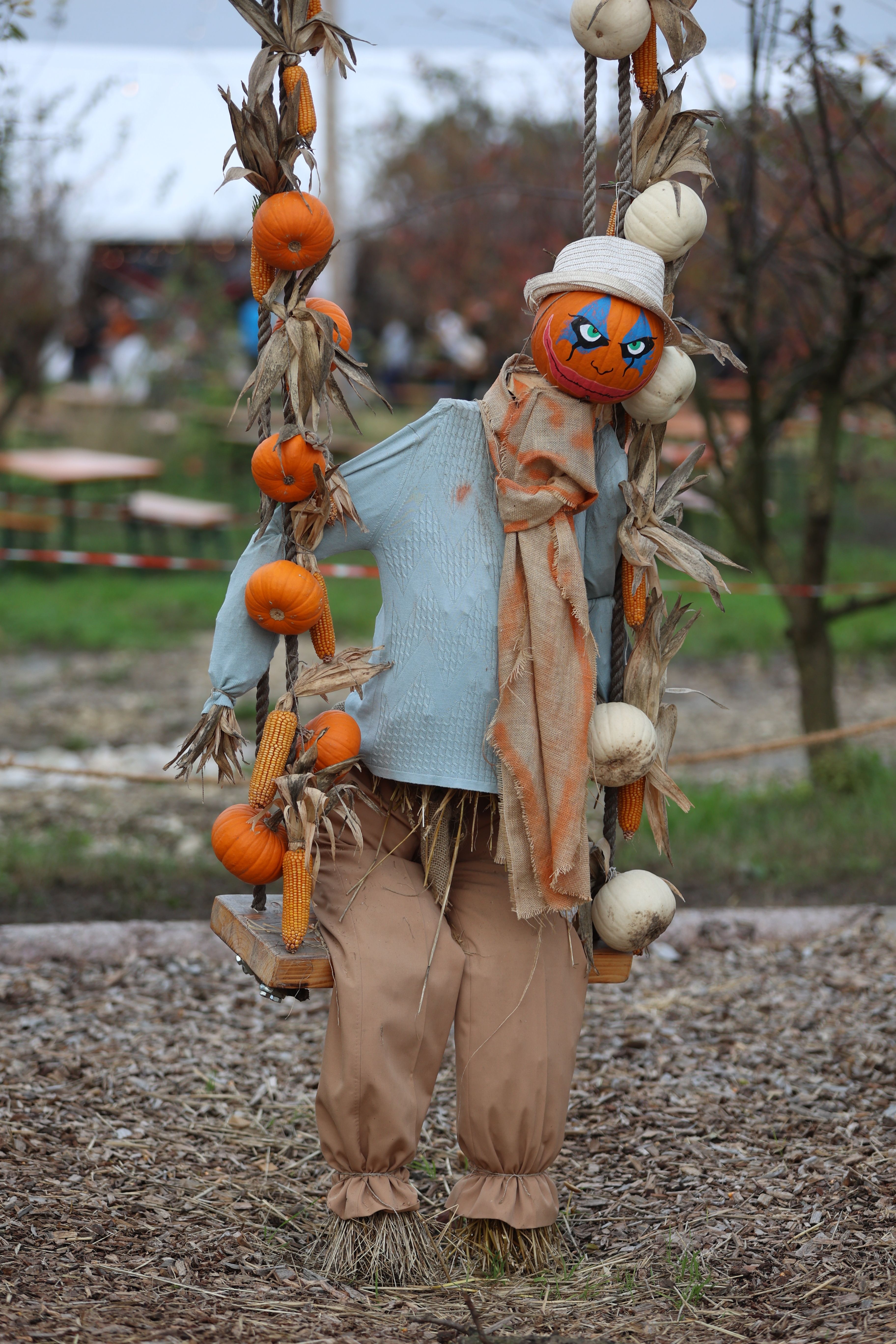 Creative Pumpkin Scarecrow Swing in Autumn Setting · Free Stock Photo