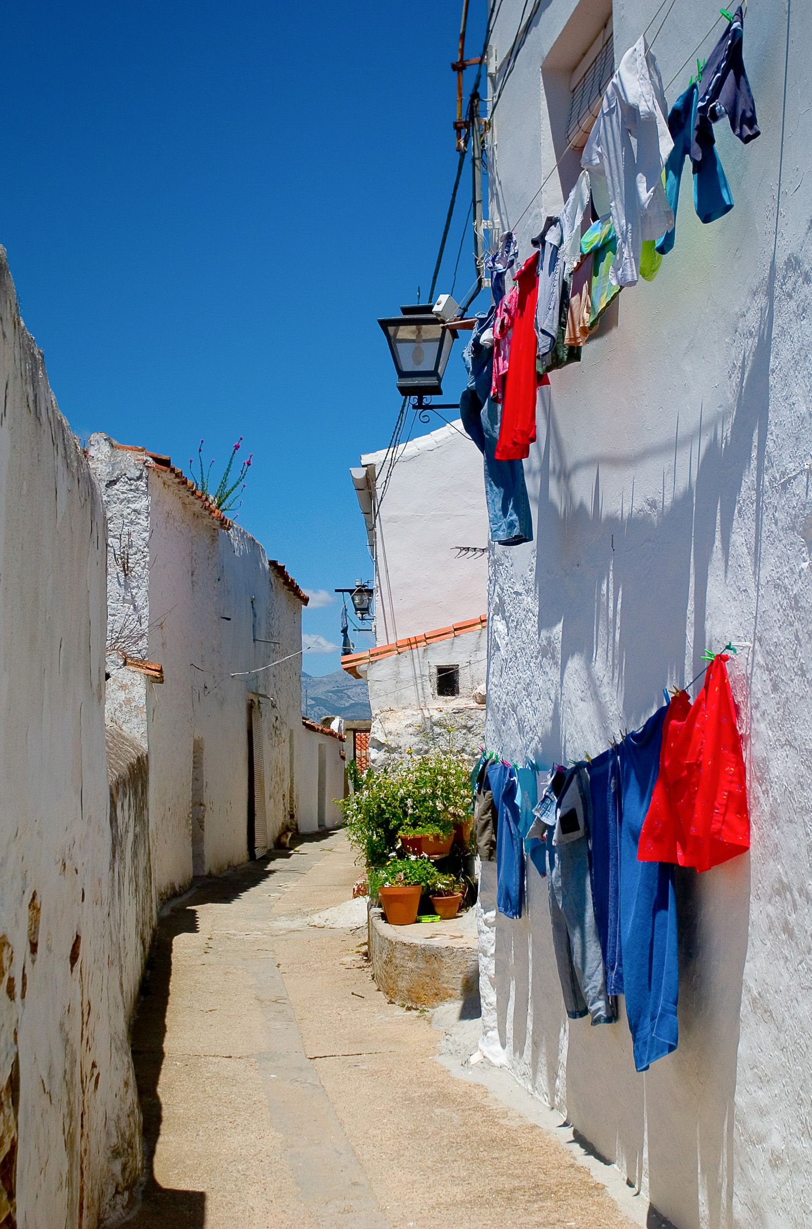 Charming Spanish Street with Colorful Laundry · Free Stock Photo