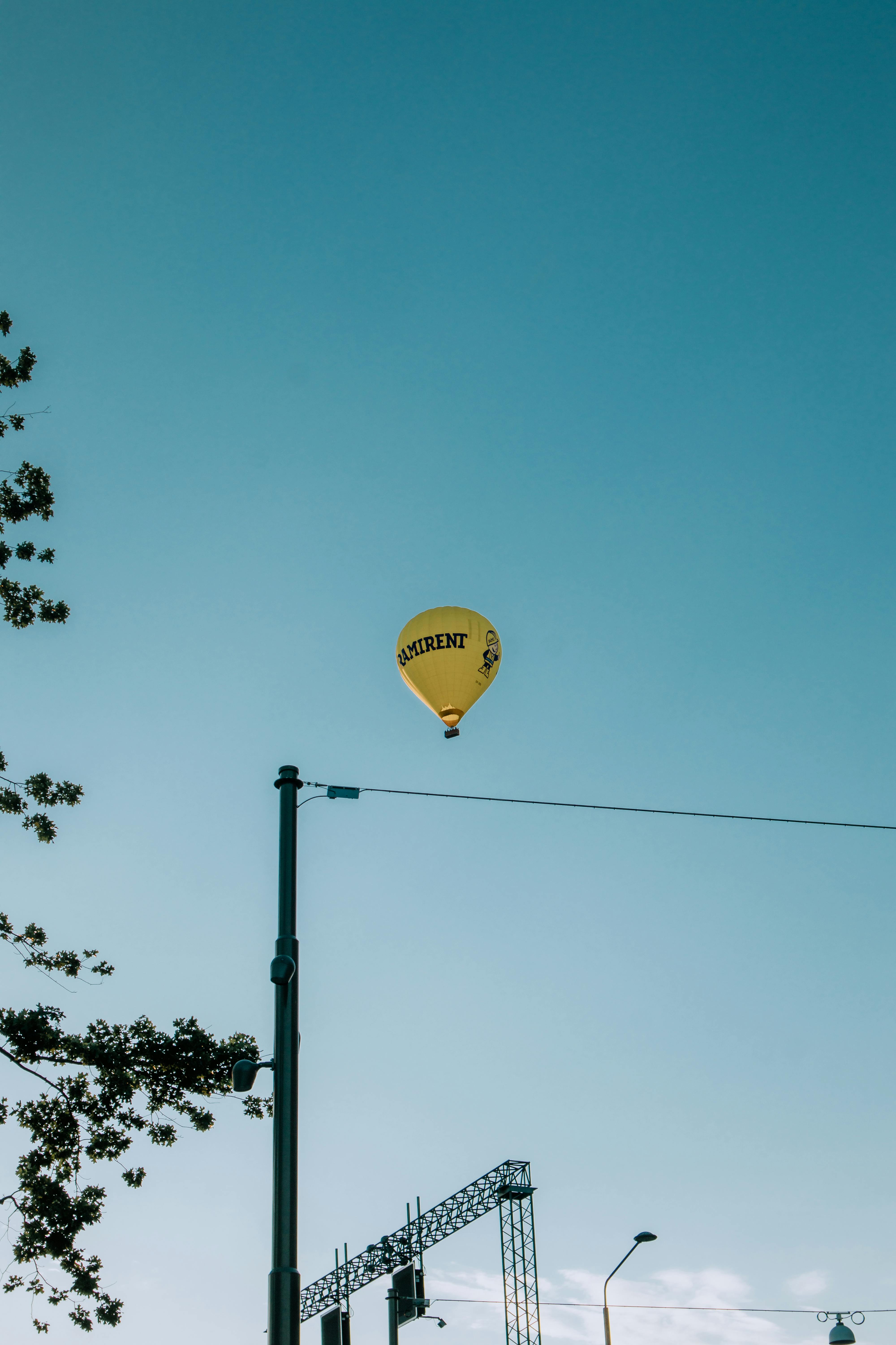 Yellow Hot Air Balloon Flying in Clear Sky · Free Stock Photo