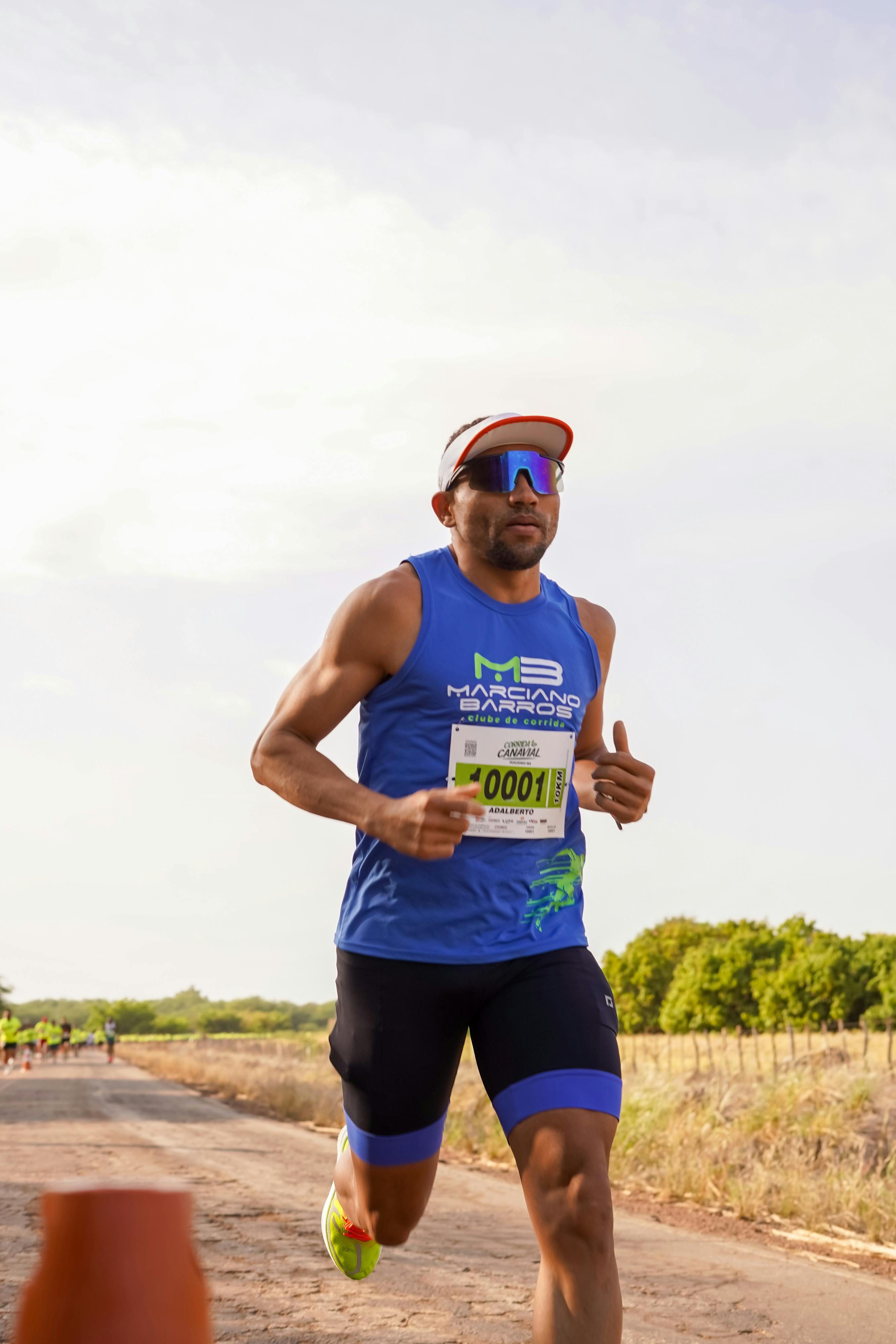 Male Runner Competing in Outdoor Marathon Race · Free Stock Photo