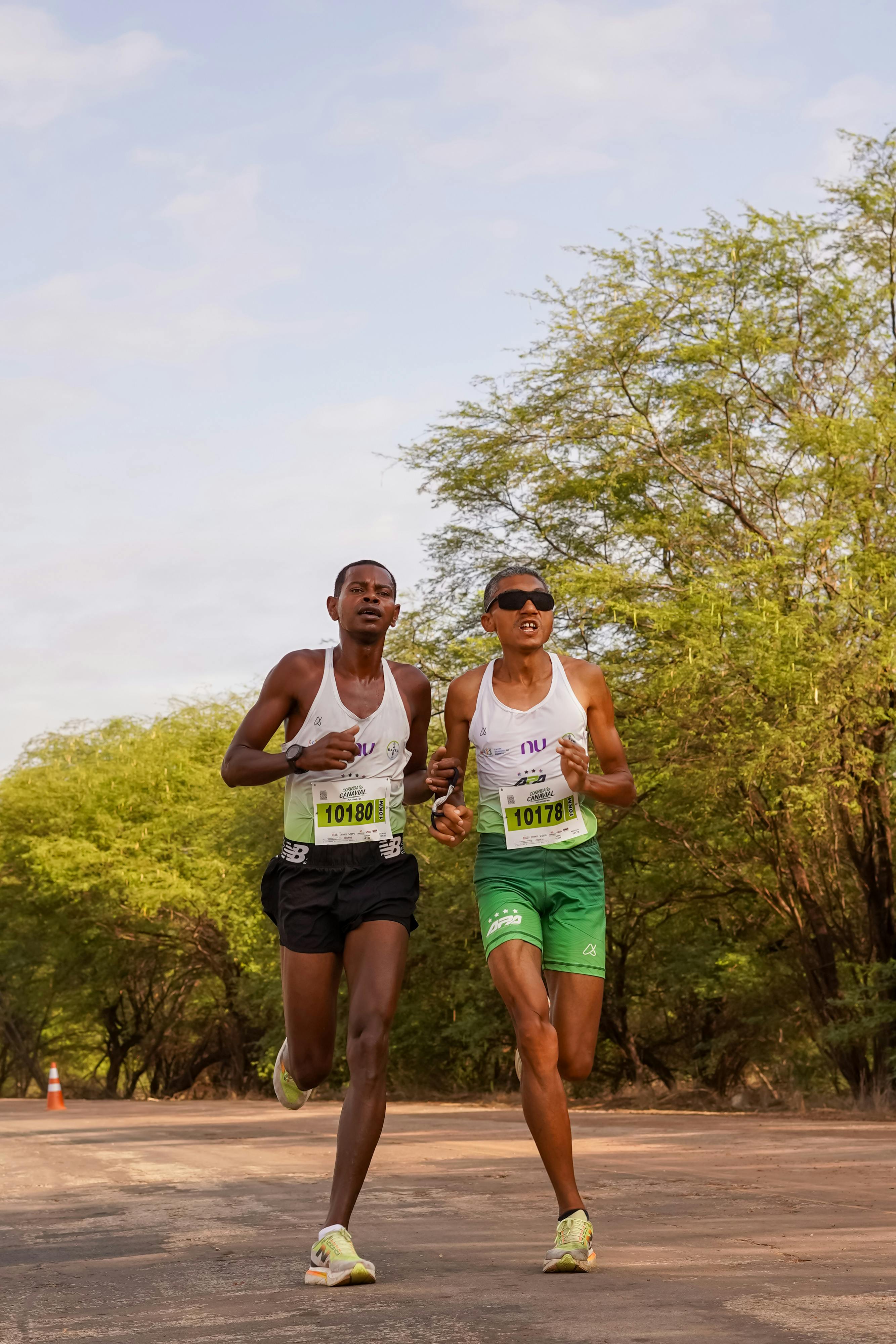 Two Athletes Competing in Outdoor Marathon · Free Stock Photo