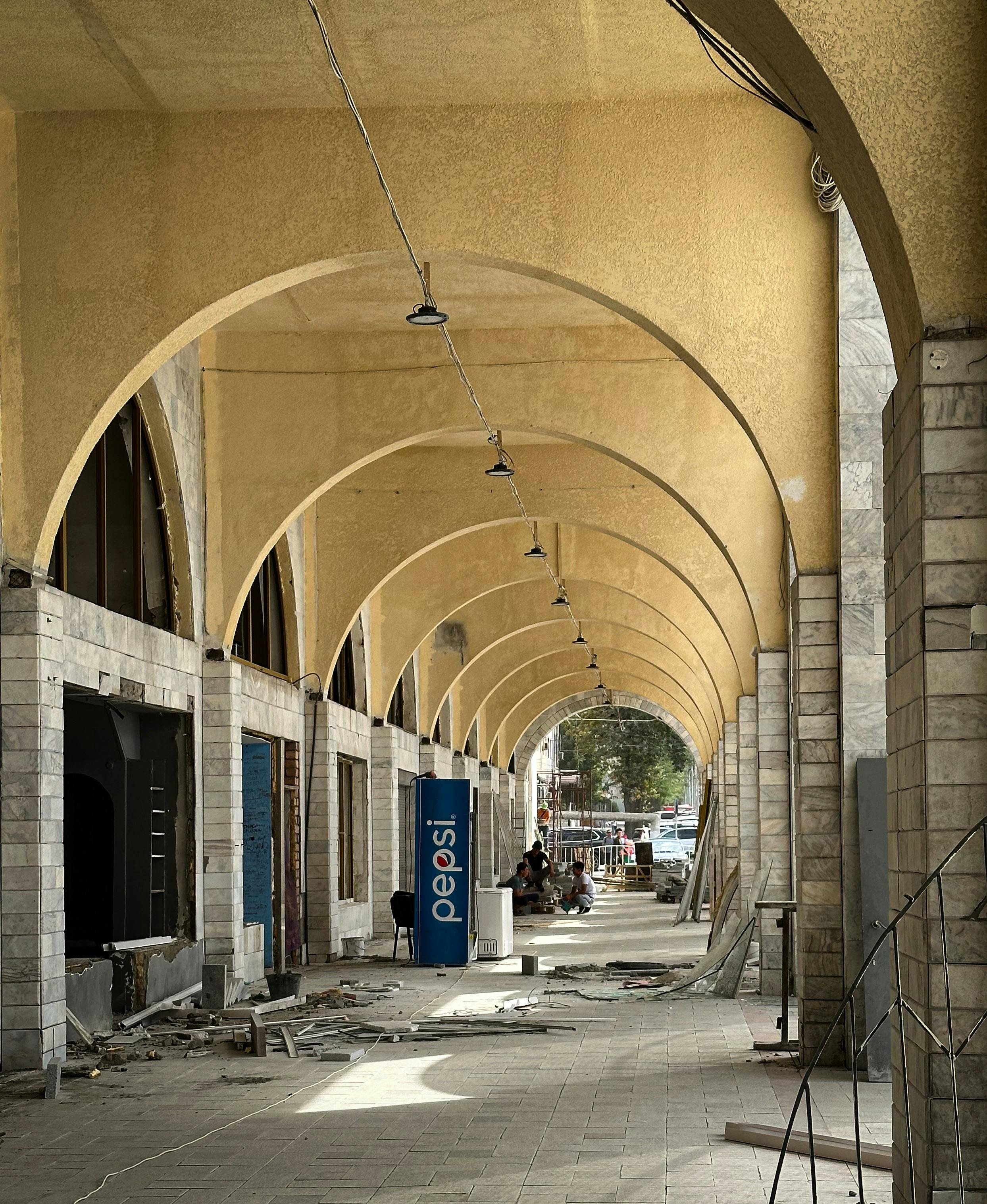 Urban Arcade with Stone Columns and Archways · Free Stock Photo