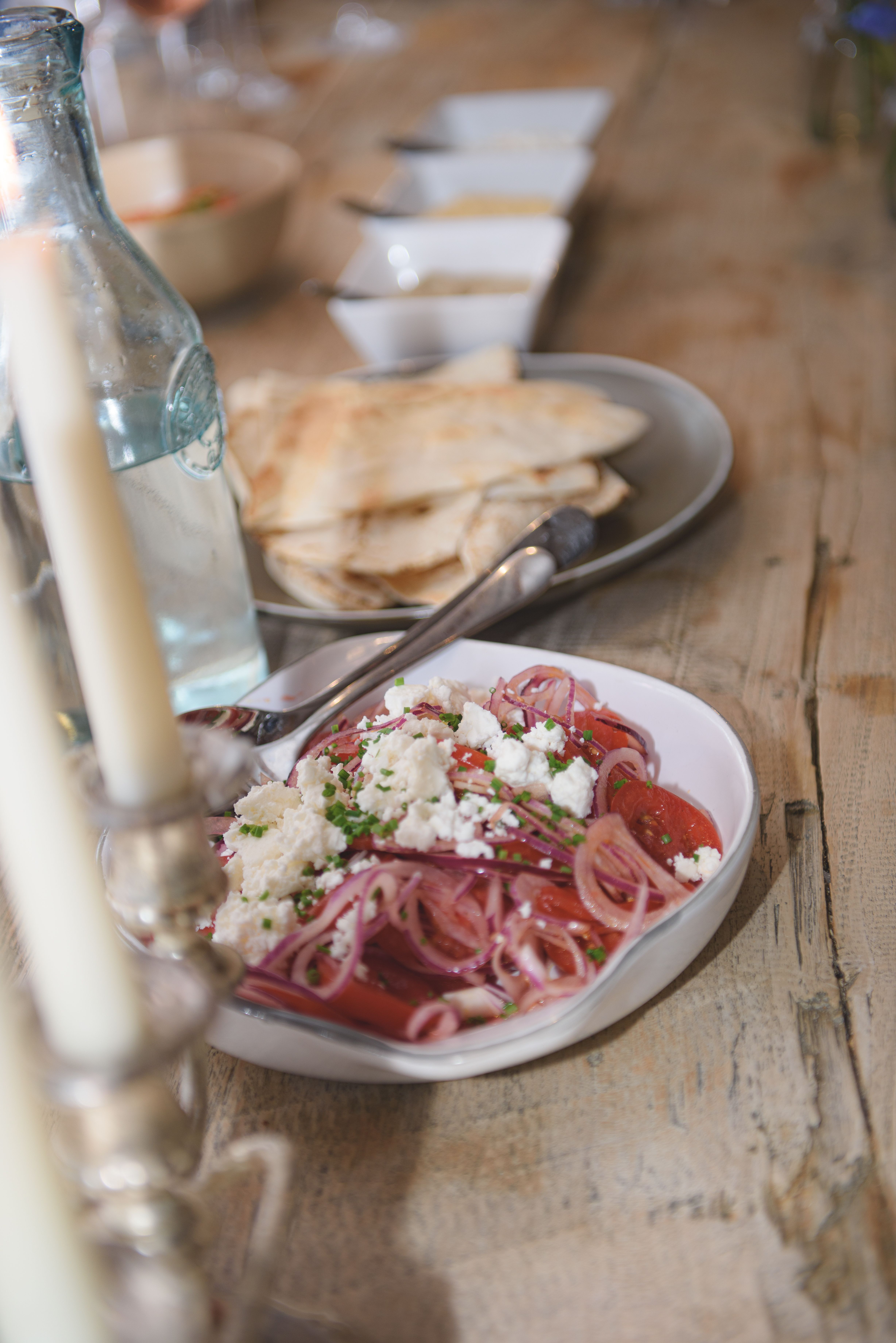 Rustic Dining Table with Fresh Tomato Salad · Free Stock Photo