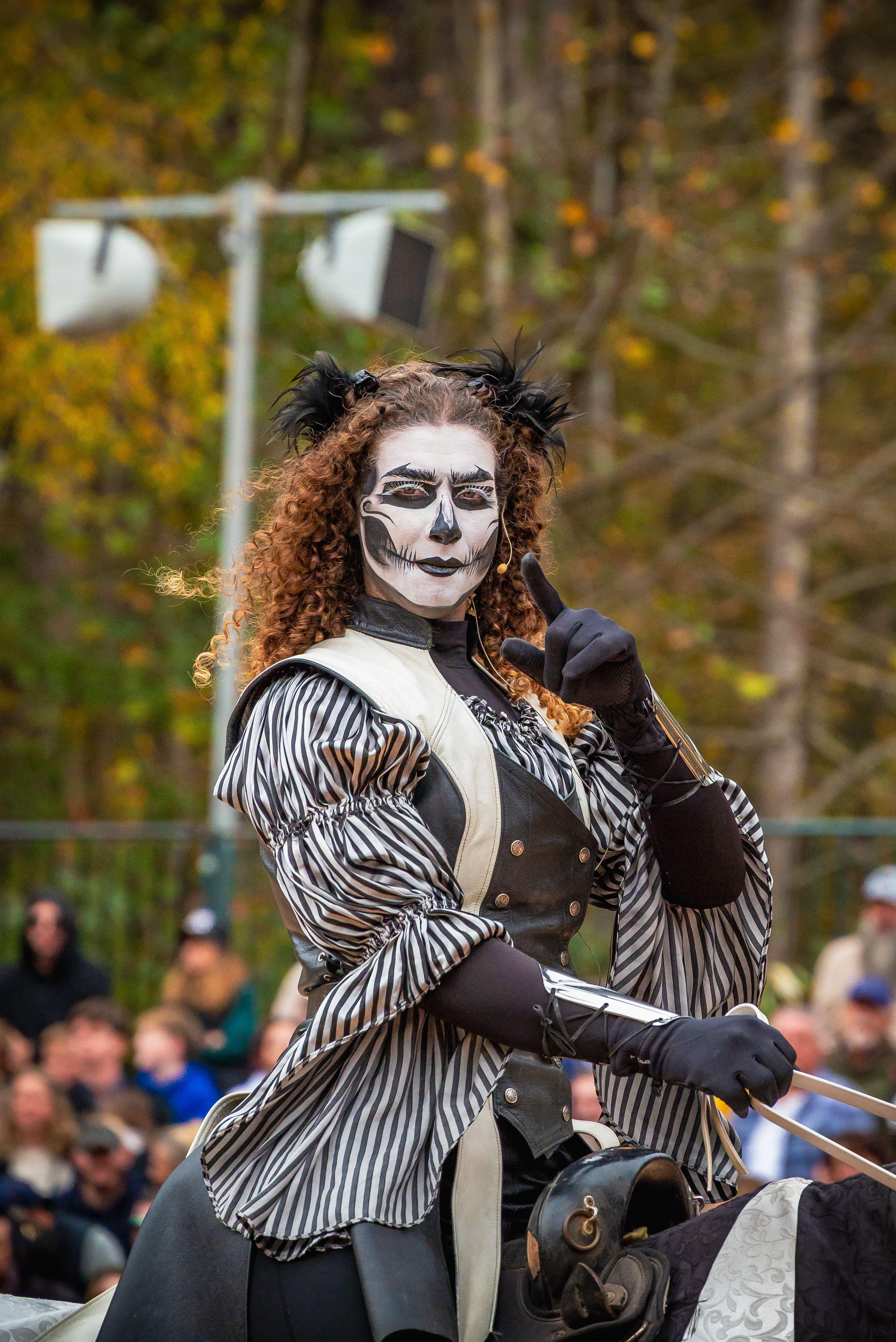 Renaissance Festival Performer in Striped Costume · Free Stock Photo