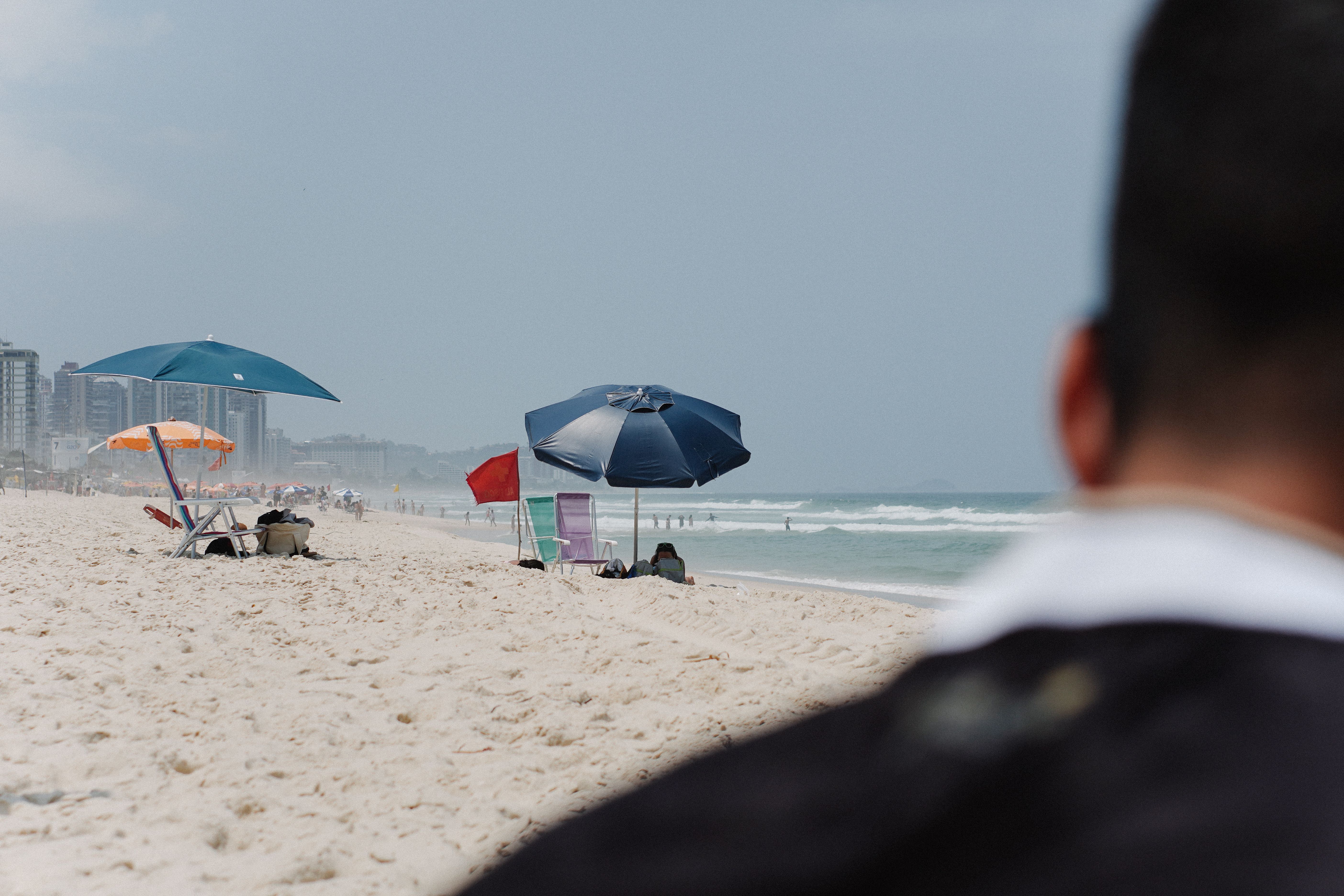Sandy Beach Scene with Umbrellas and Sea View · Free Stock Photo