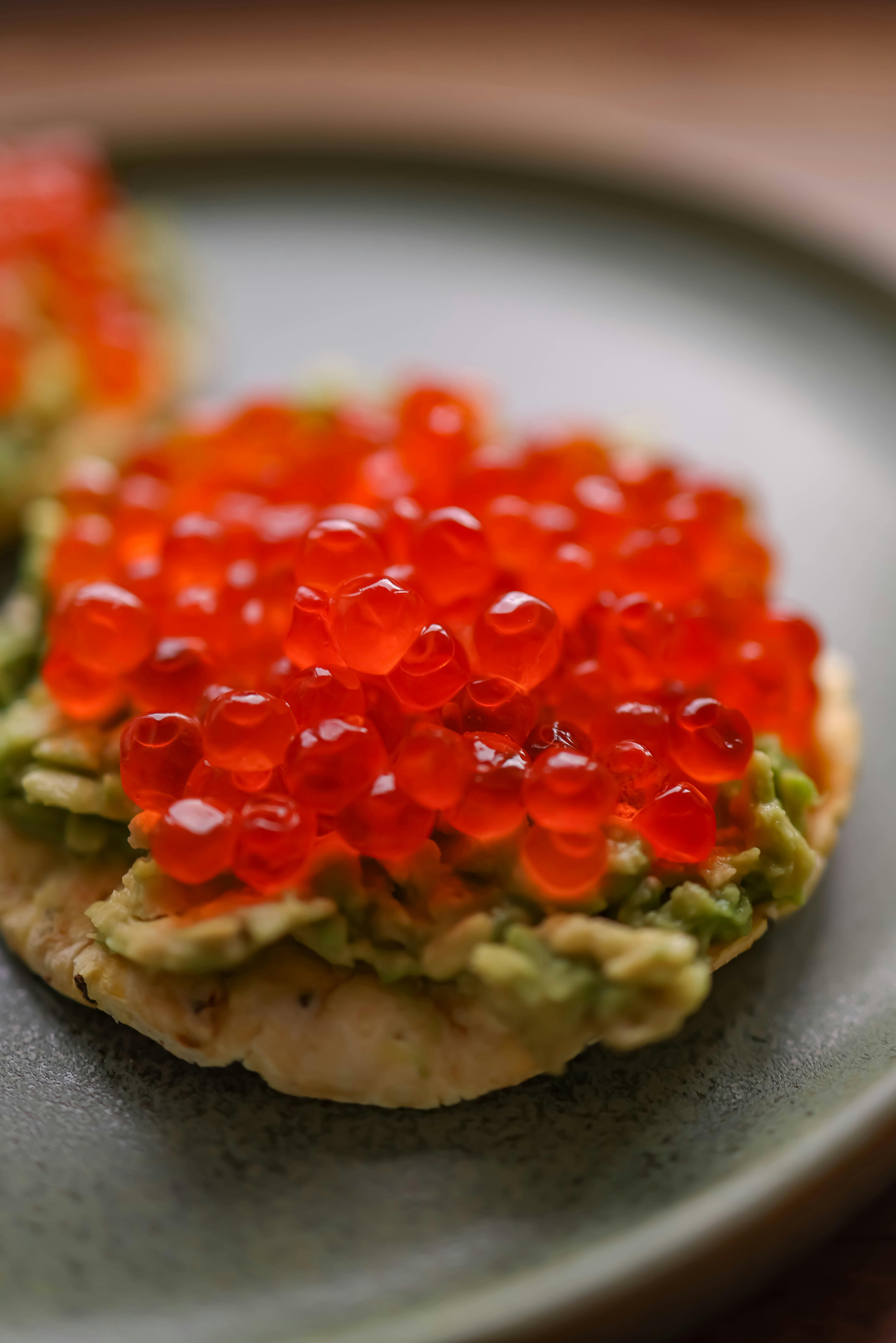 Close-up of Salmon Roe on Avocado and Cracker · Free Stock Photo