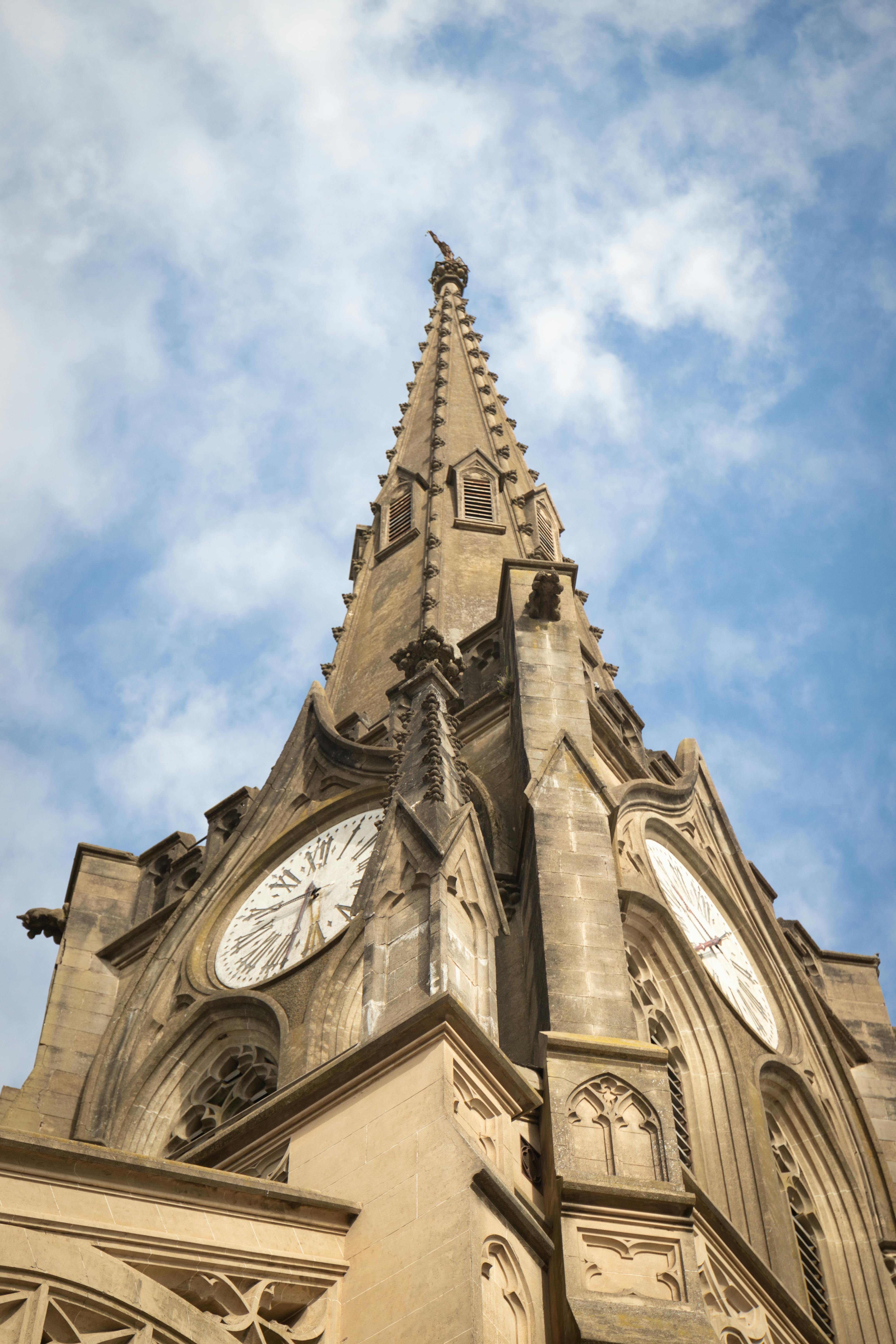 Imposing Gothic Church Spire Against Blue Sky · Free Stock Photo