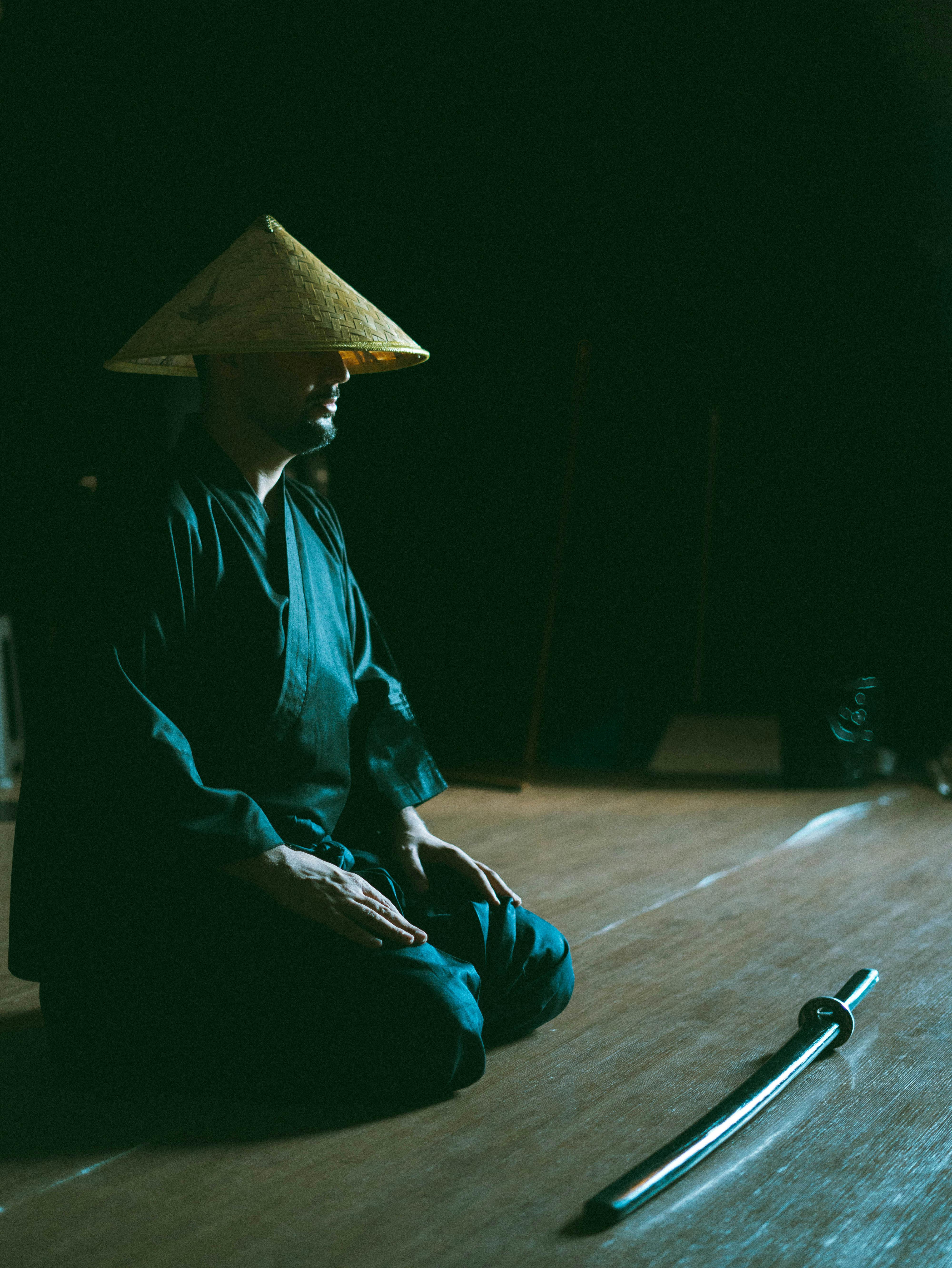 Samurai Meditation with Katana in Dim Light · Free Stock Photo