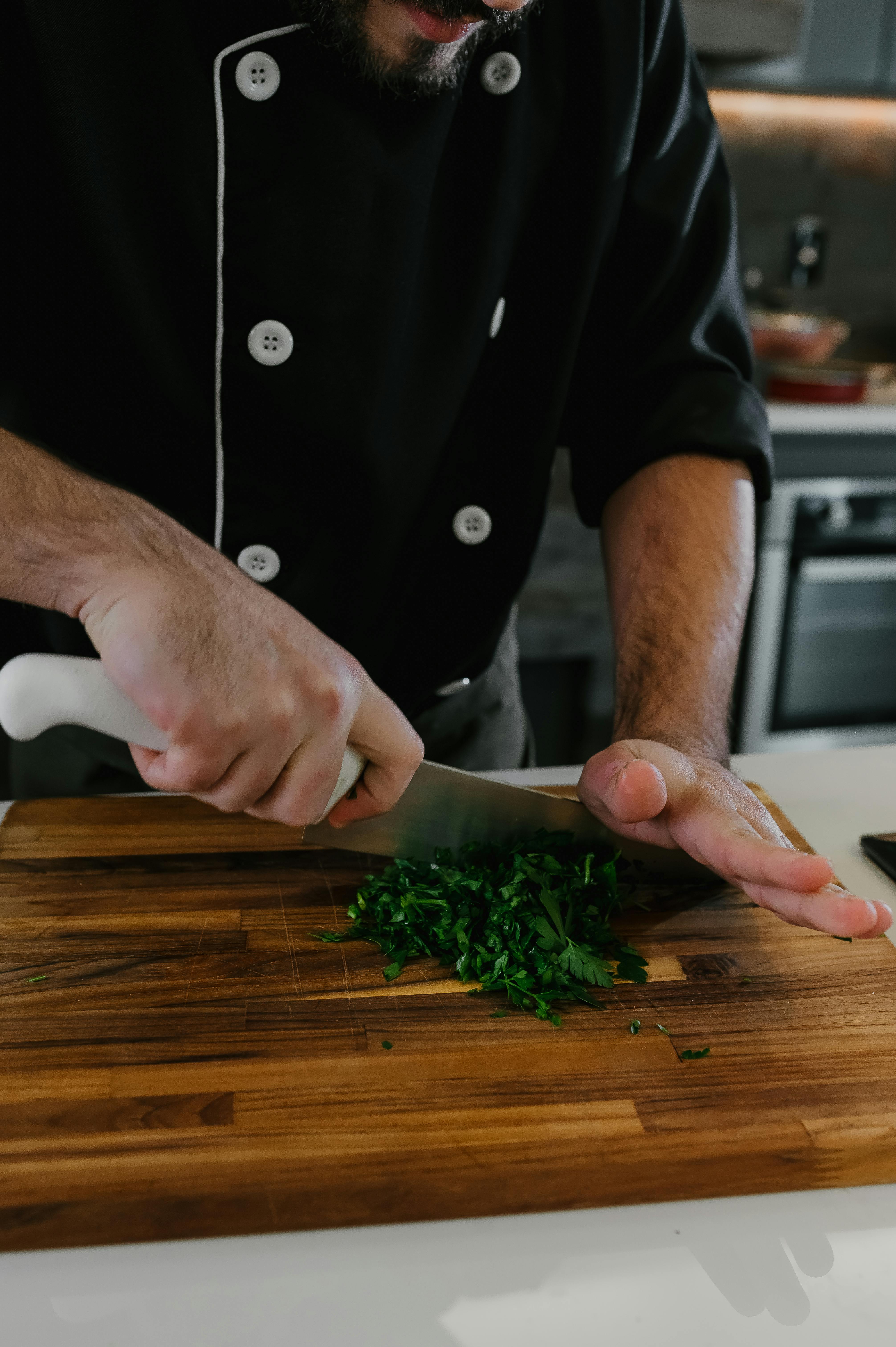 Chef Chopping Fresh Herbs on Wooden Board · Free Stock Photo
