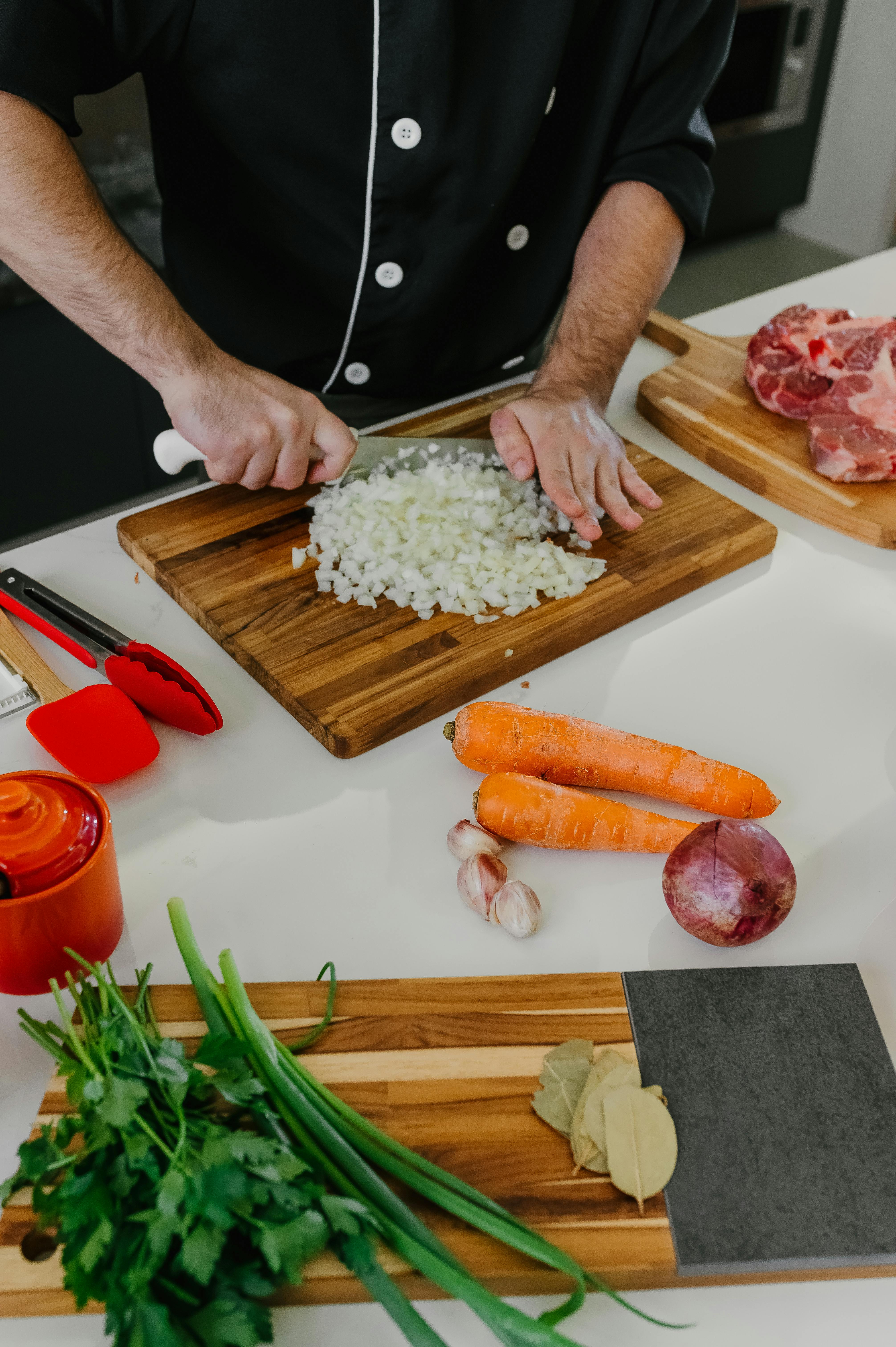 Chef Chopping Onions in a Modern Kitchen · Free Stock Photo
