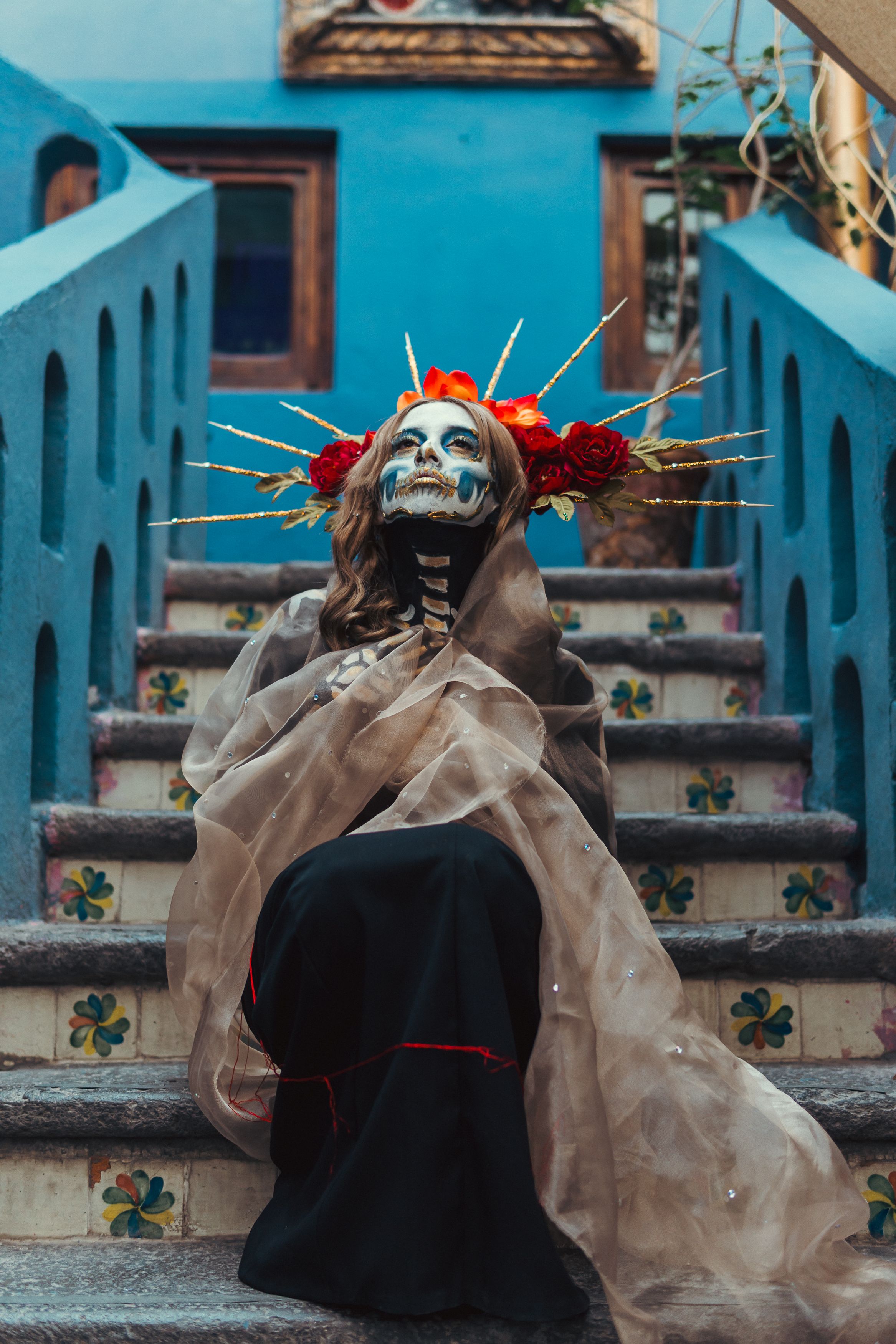 La Catrina Sitting on Decorated Steps · Free Stock Photo
