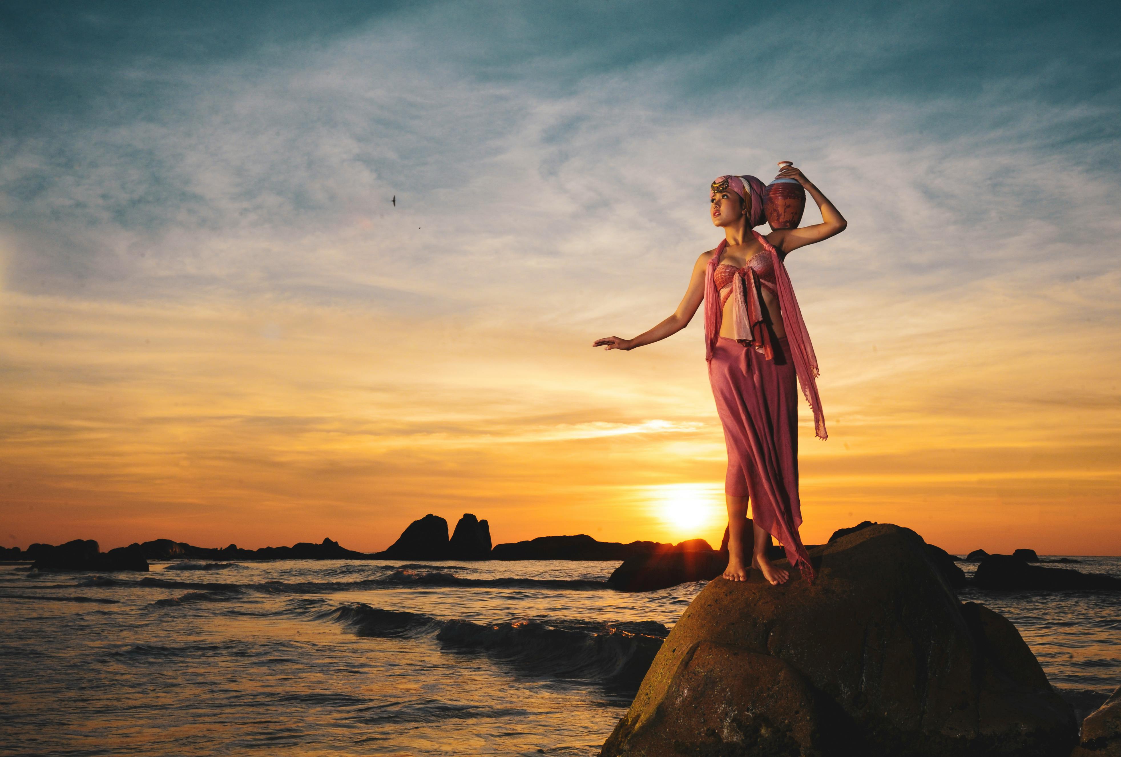 Sunrise Model Posing on Rock in Phan Thiet Beach · Free Stock Photo