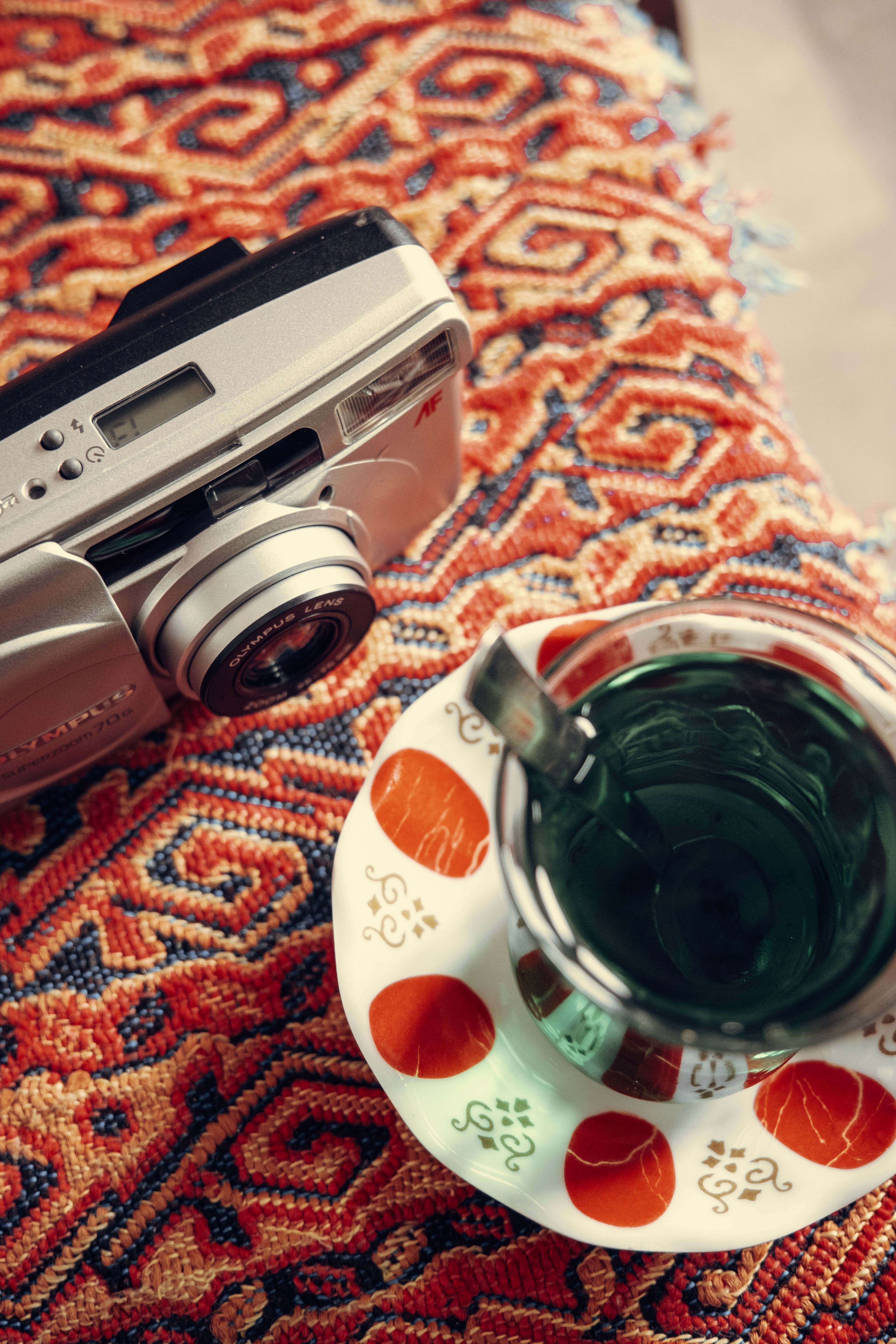 Vintage Camera and Tea on Patterned Fabric · Free Stock Photo