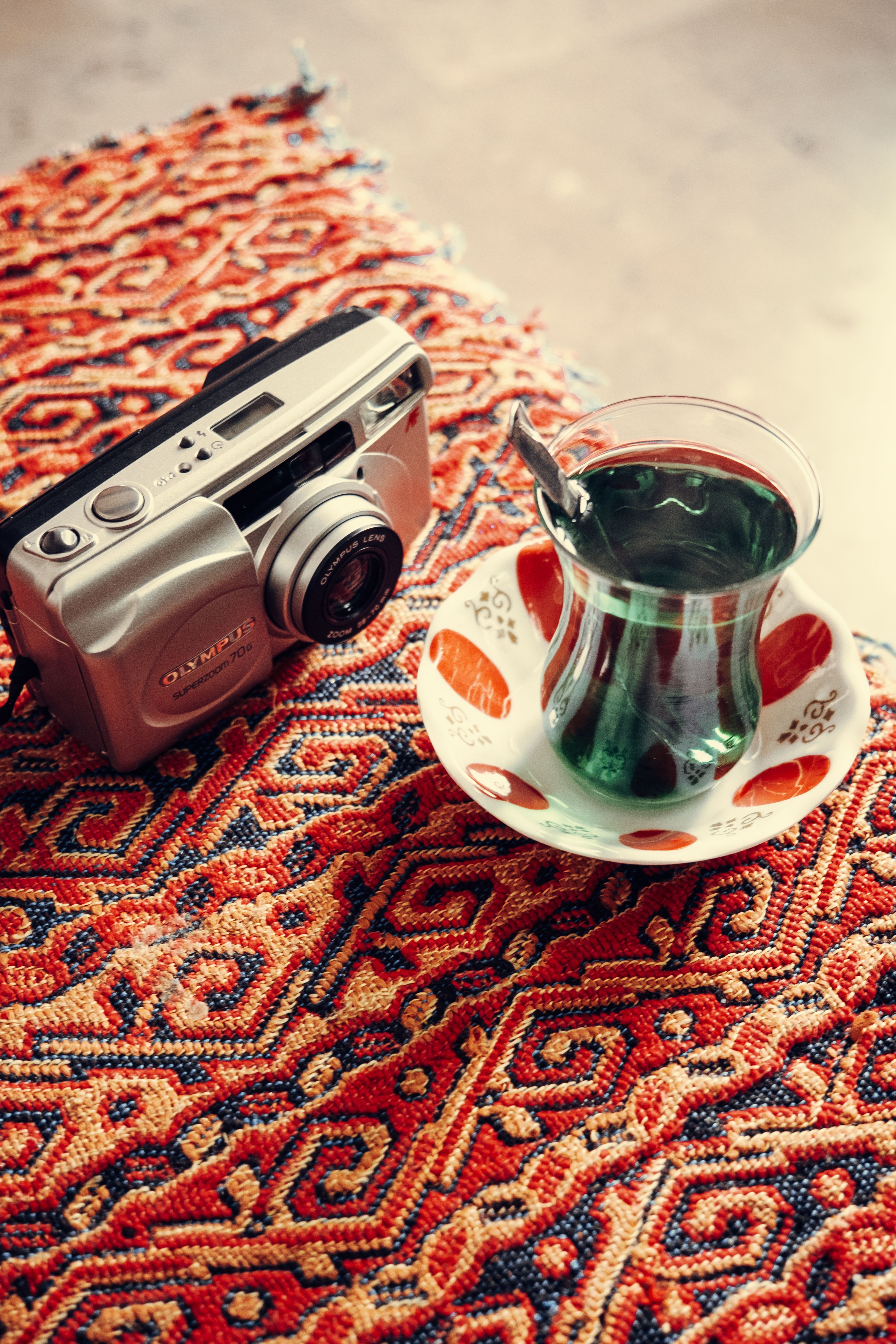 Vintage Camera and Tea on Patterned Rug · Free Stock Photo