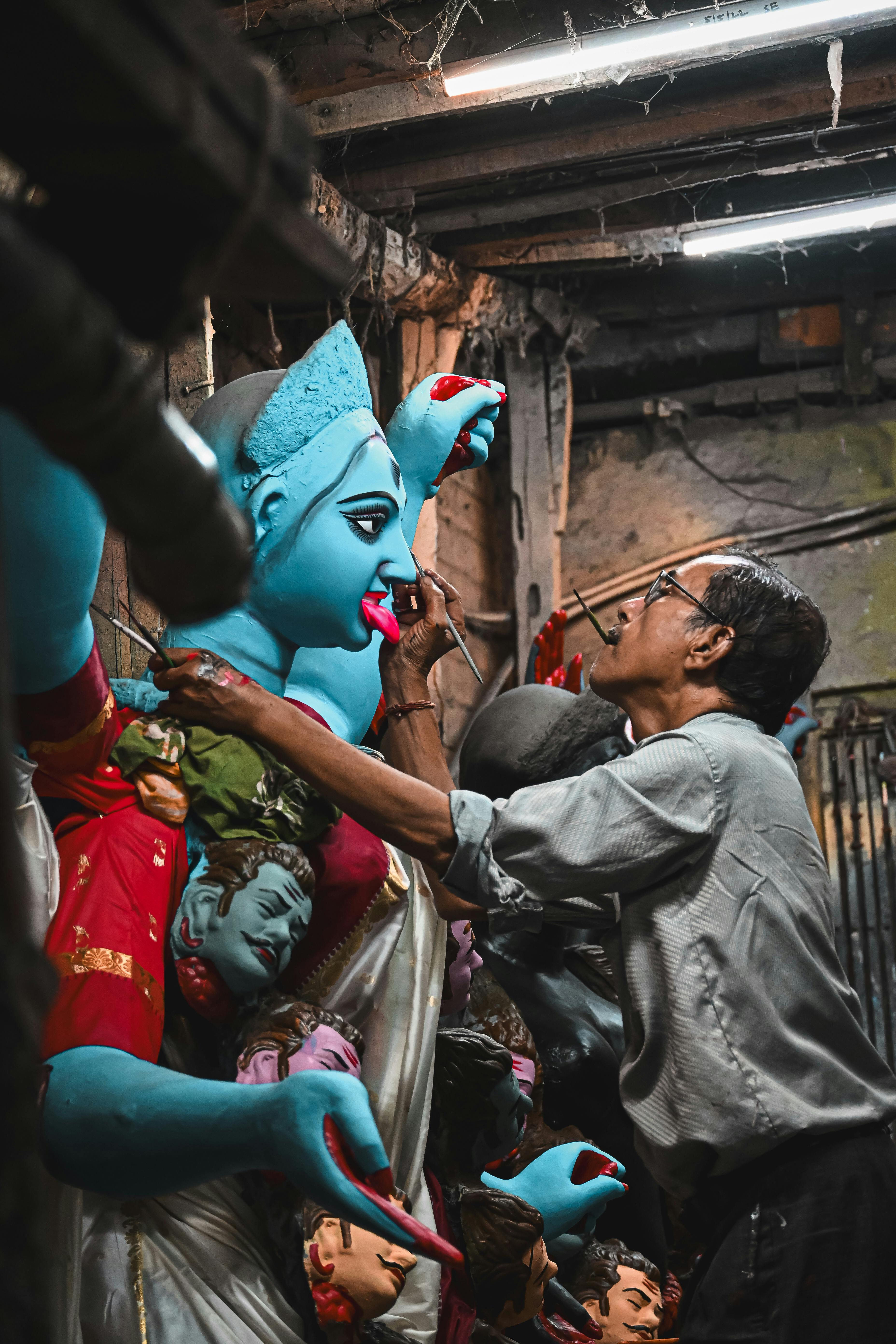 Artisan Painting Goddess Kali Idol in Kolkata Workshop · Free Stock Photo