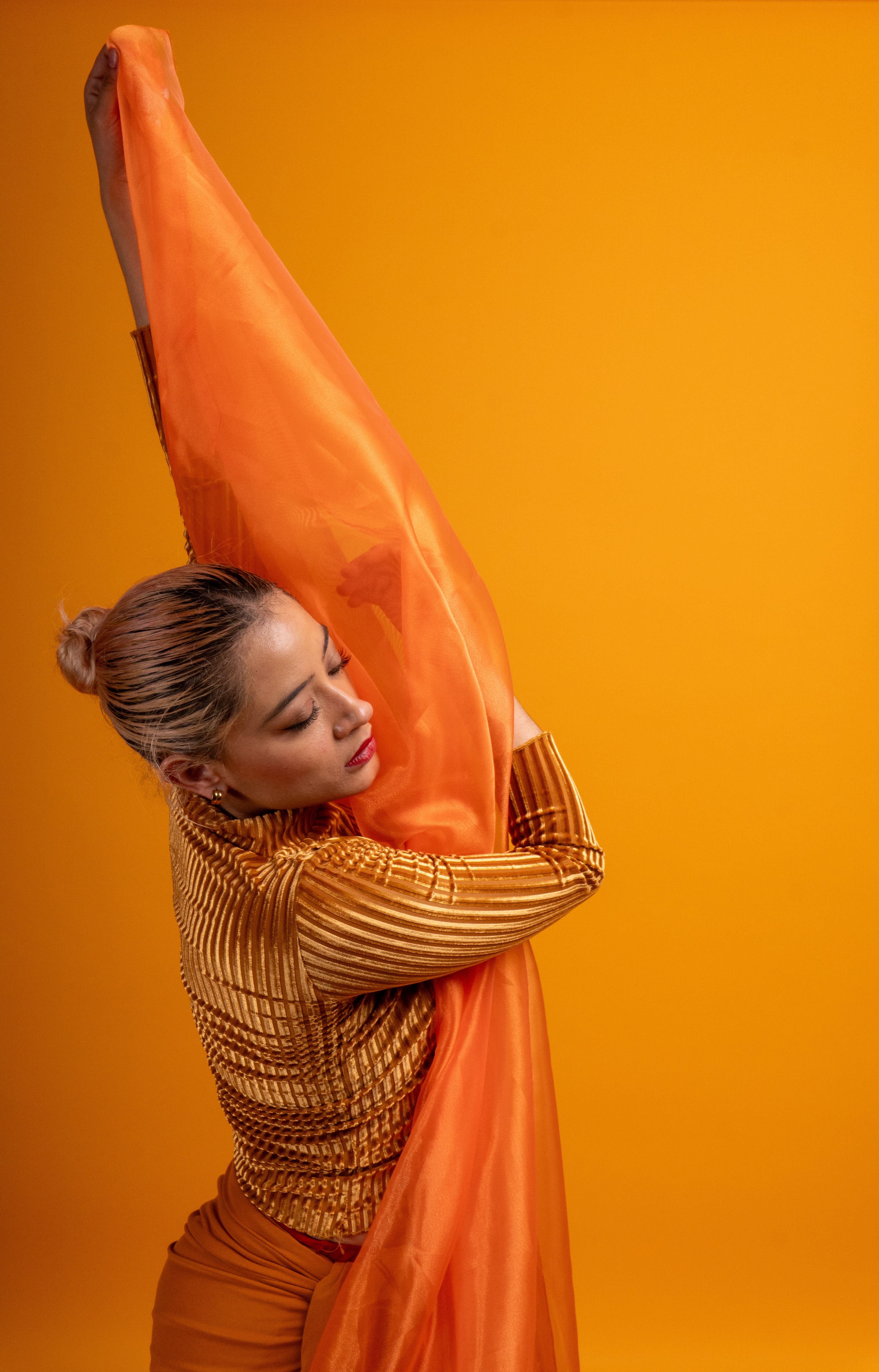 Elegant Dance Pose with Flowing Orange Fabric · Free Stock Photo