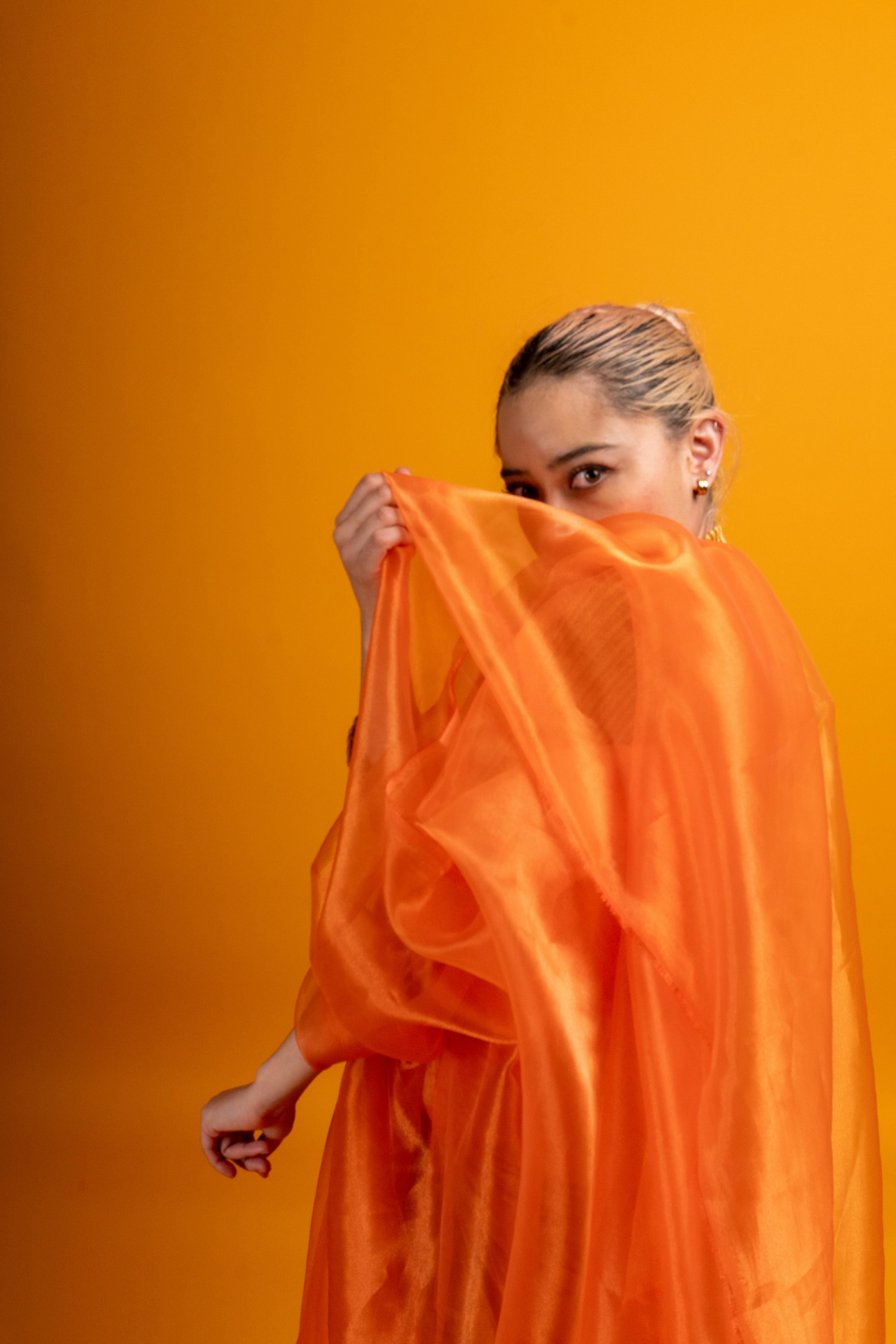 Elegant Portrait of Woman in Vibrant Orange · Free Stock Photo