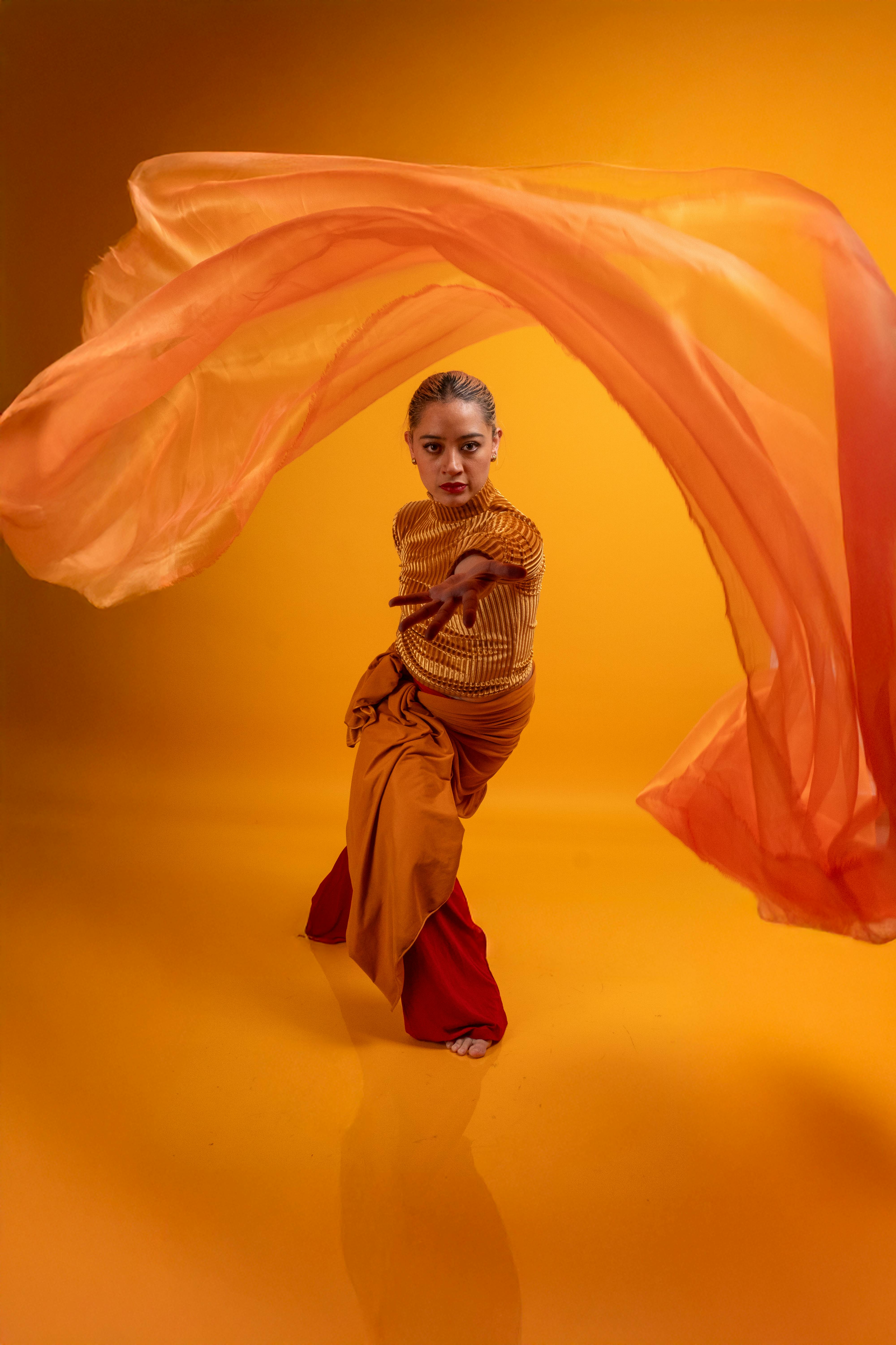 Dynamic Contemporary Dancer in Orange Flowing Fabric · Free Stock Photo