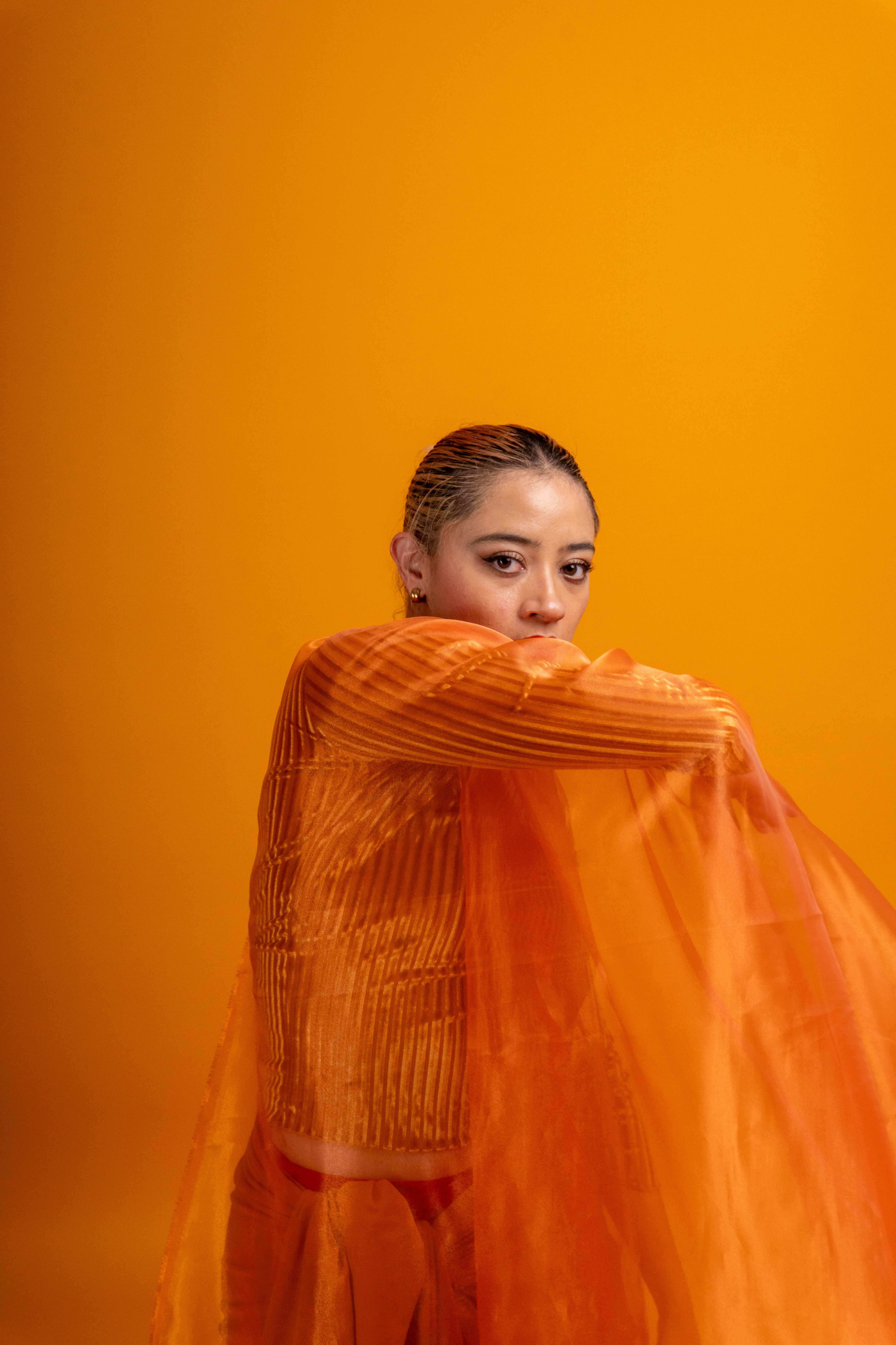 Stunning Female Dancer in Vibrant Orange Ensemble · Free Stock Photo