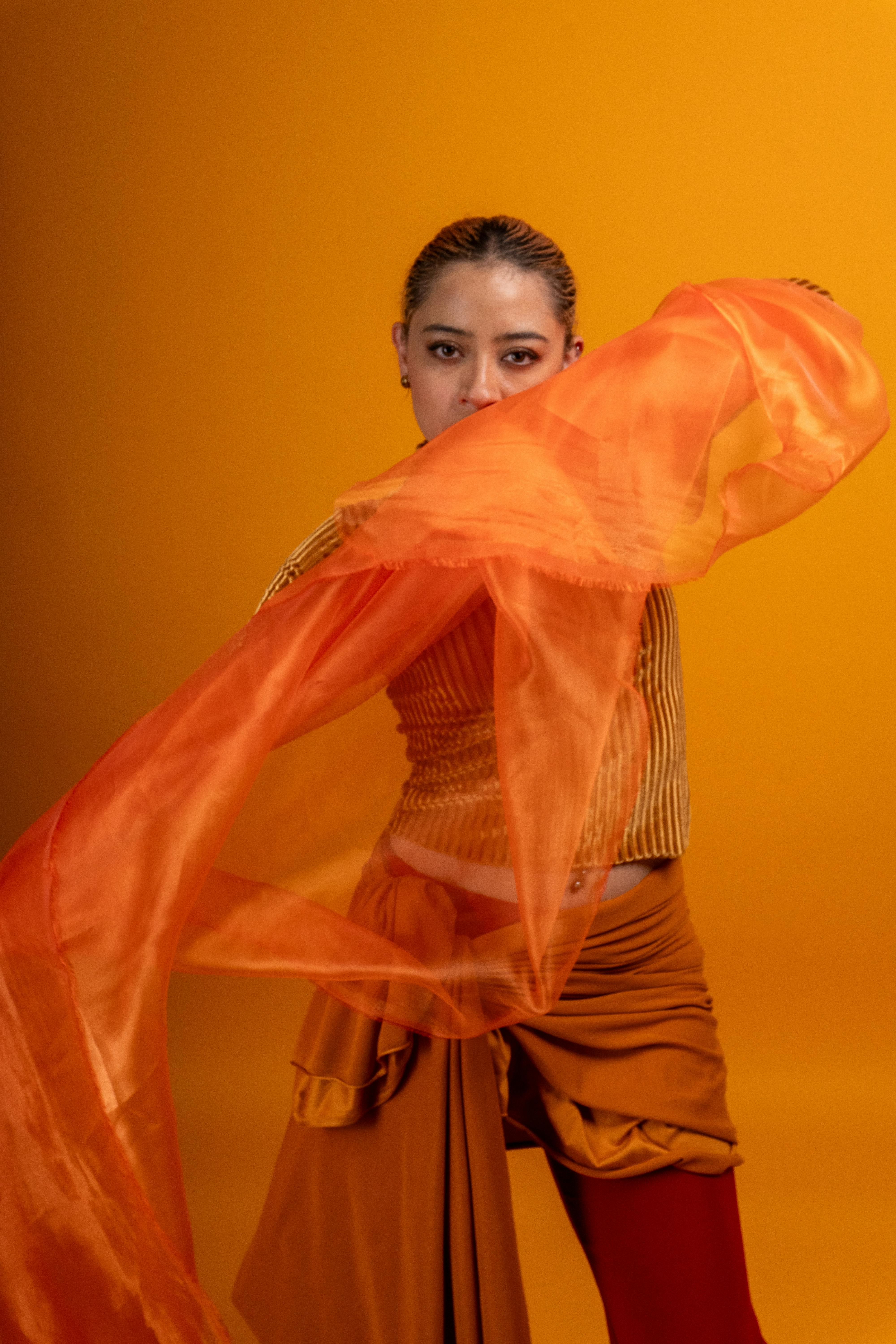 Elegant Ballet Dancer in Flowing Orange Fabric · Free Stock Photo