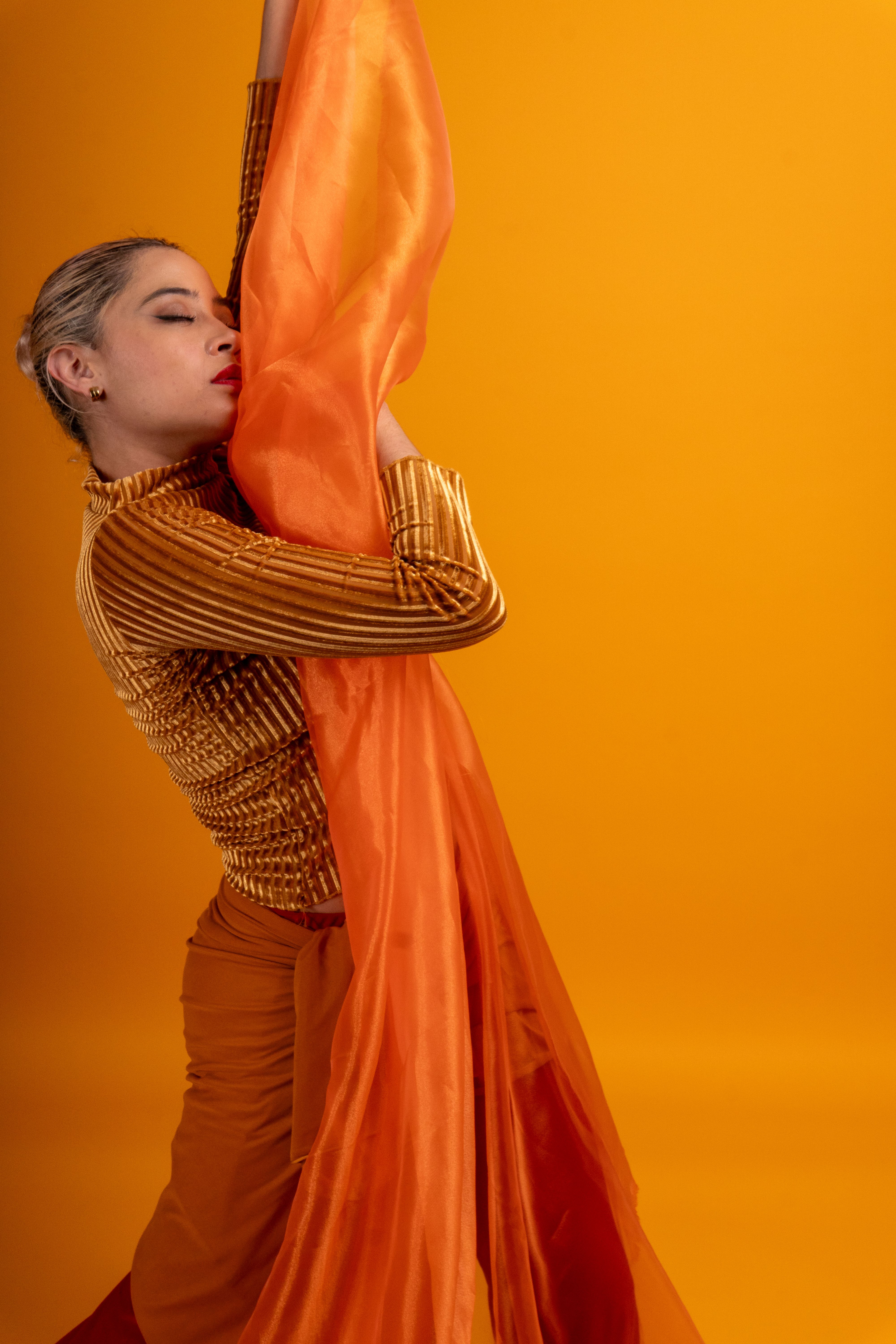 Dynamic Female Dancer in Orange Attire · Free Stock Photo