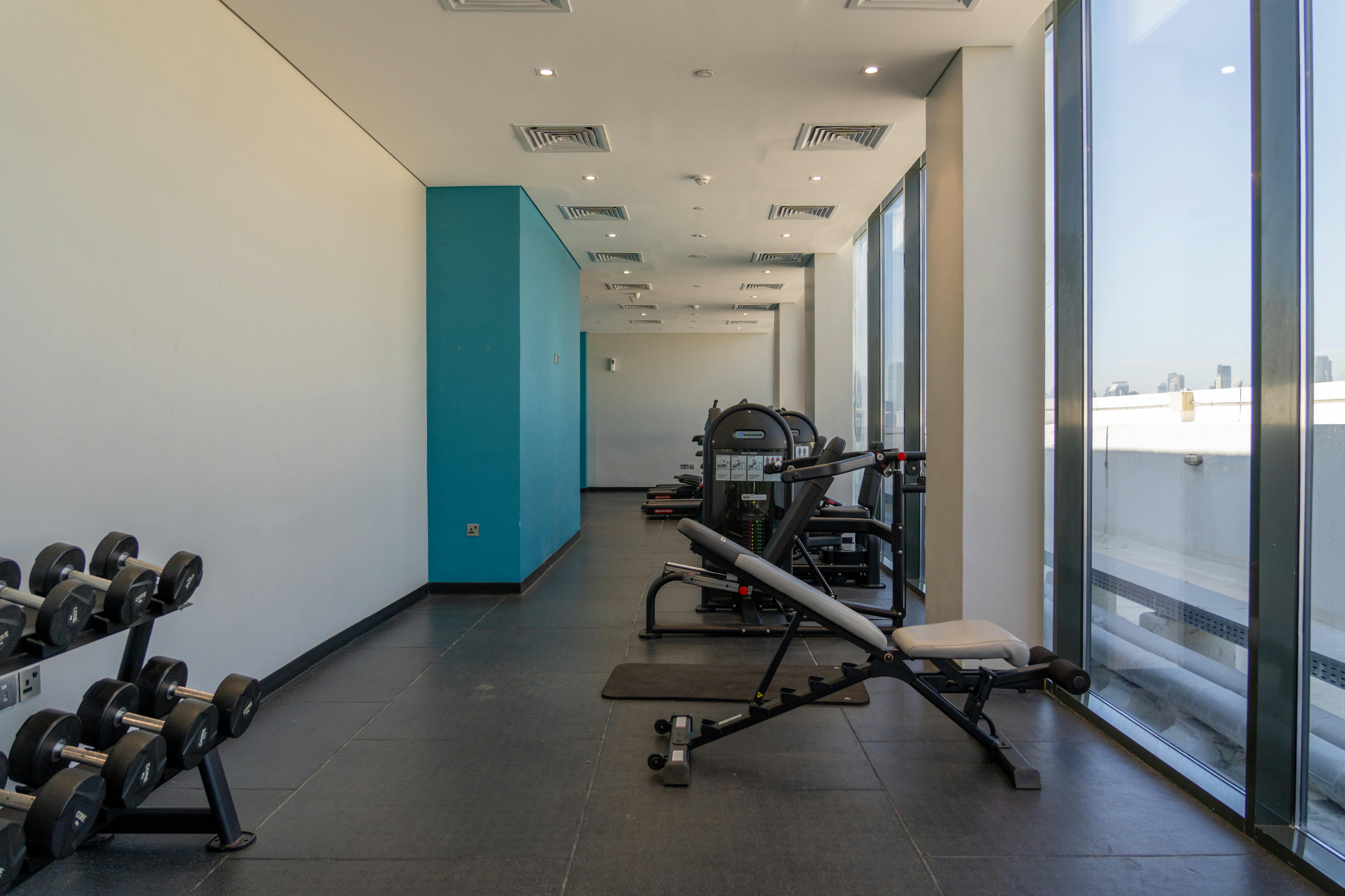 Interior of modern fitness club with various machines and equipment ...
