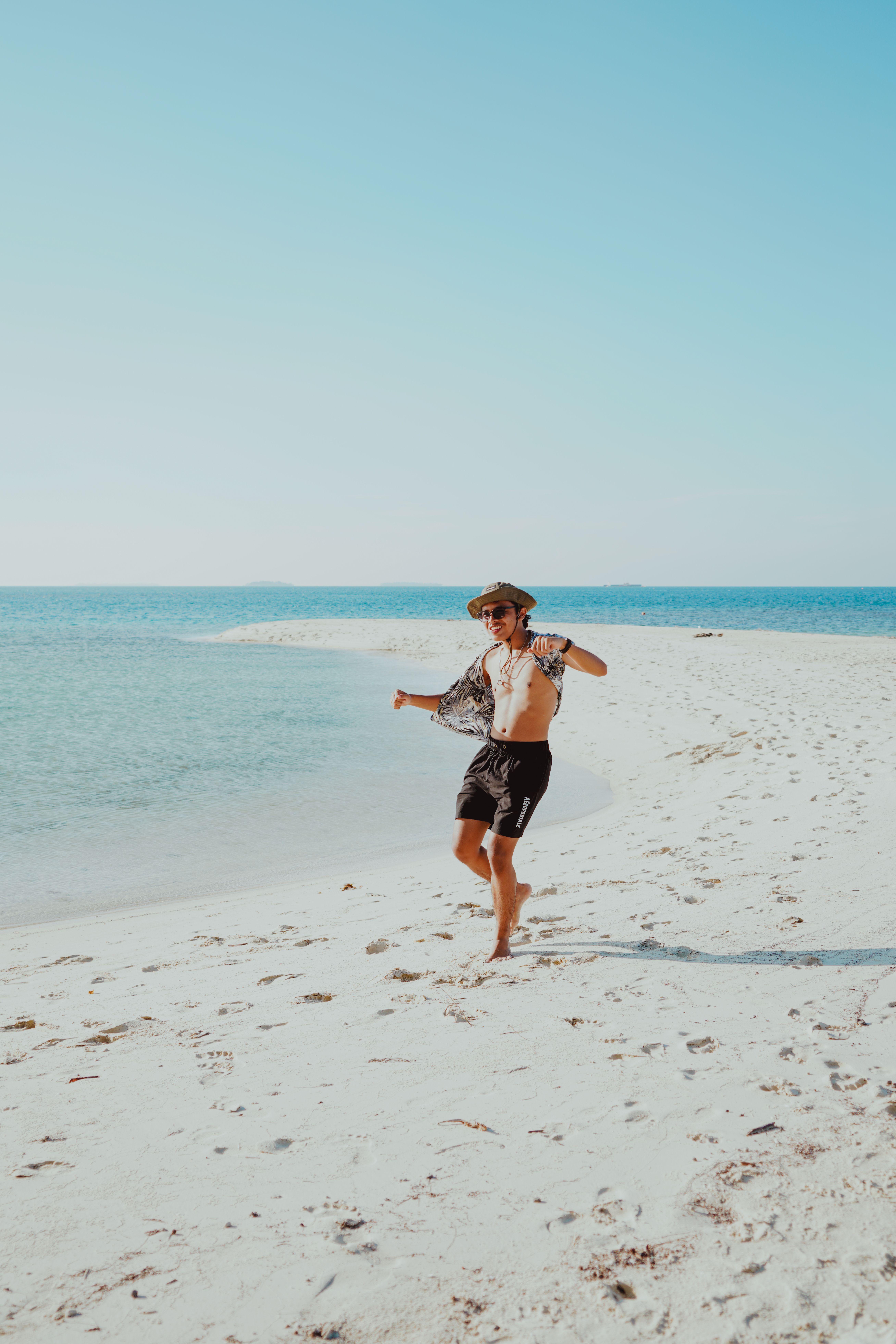 Man Enjoying a Sunny Beach Day in Summer · Free Stock Photo
