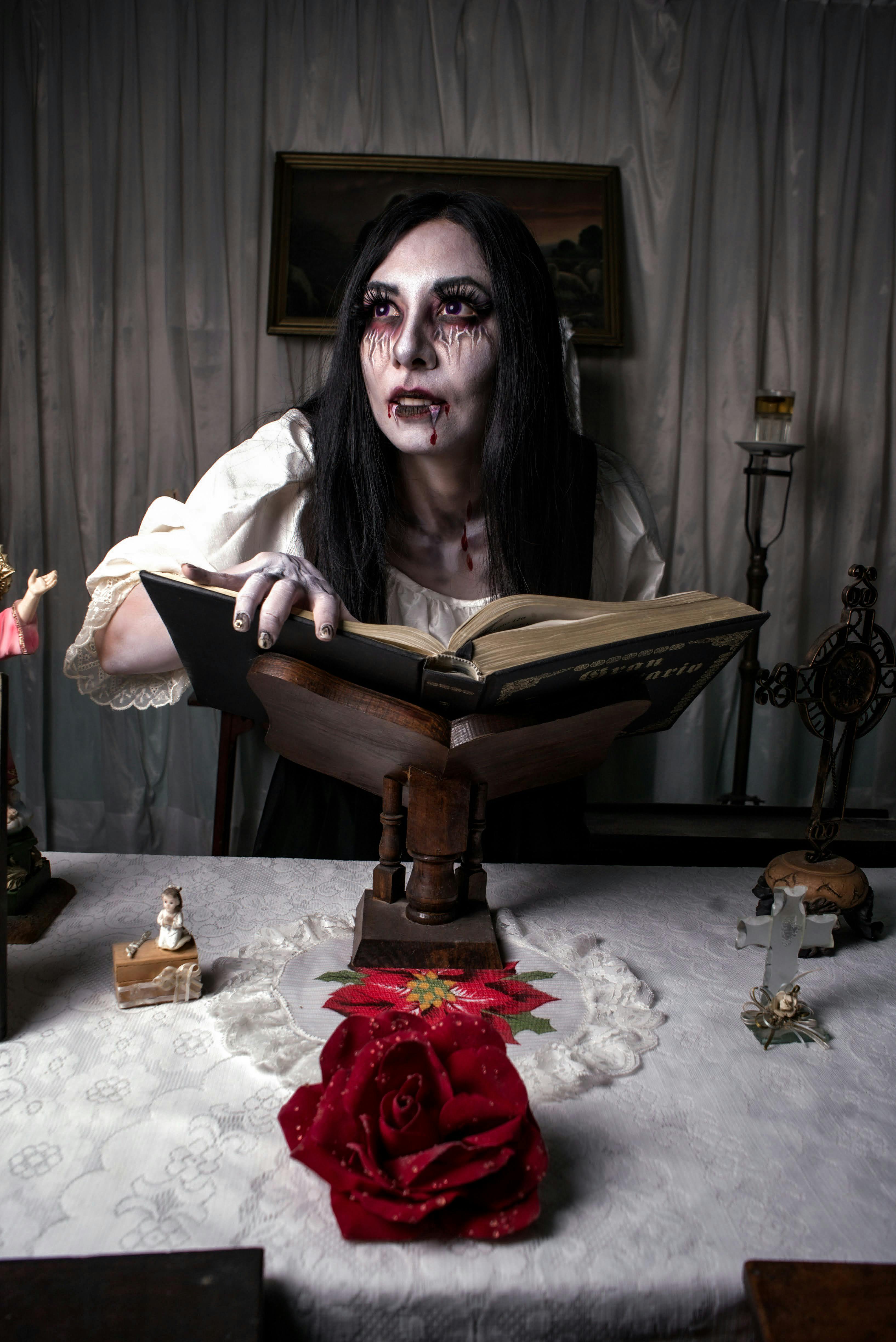 Gothic Woman Reading a Spellbook at Night · Free Stock Photo