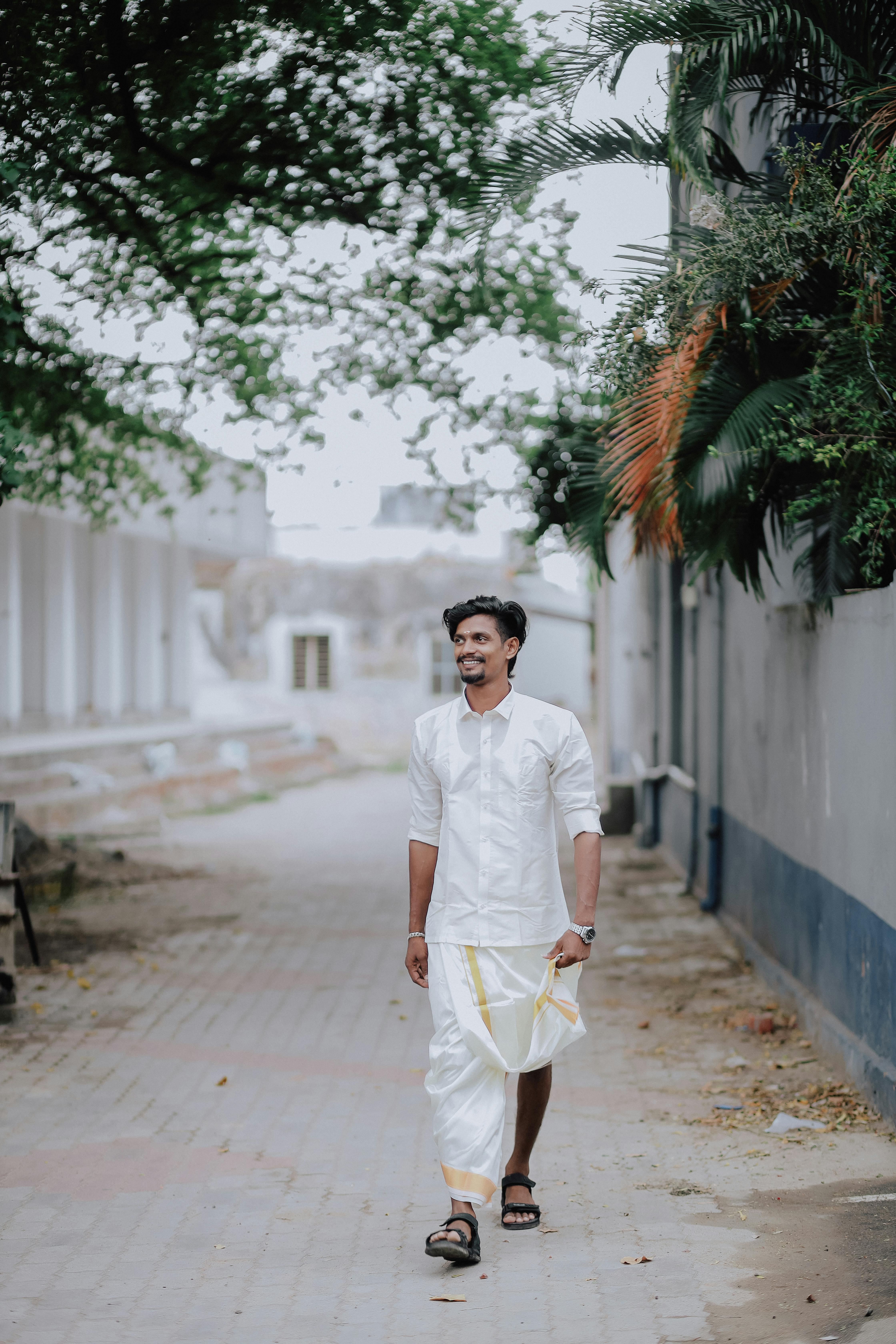 Traditional Indian Man in Ethnic Attire Walking Outdoors · Free Stock Photo
