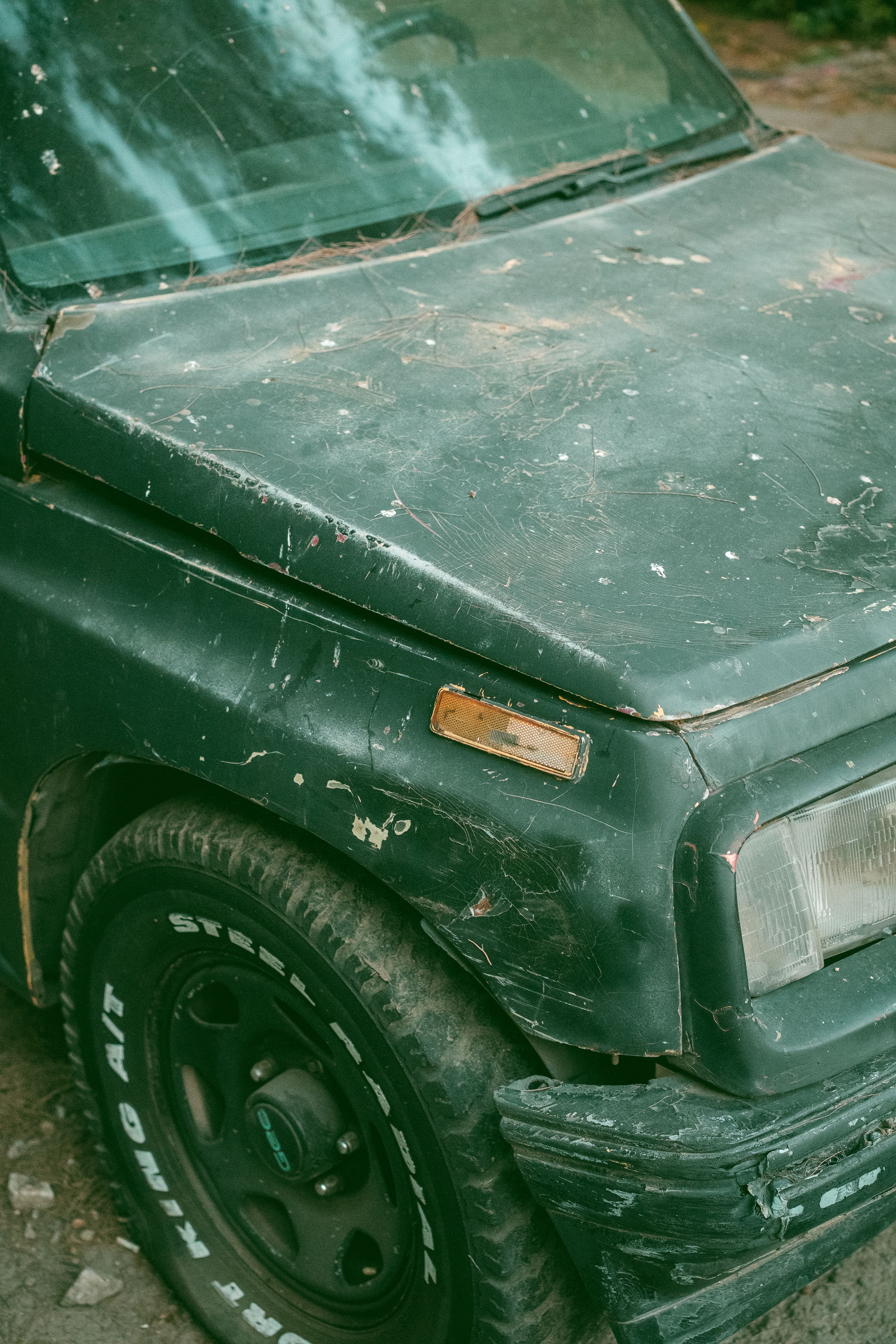 Weathered Green Car with Scratched Paint in Daylight · Free Stock Photo